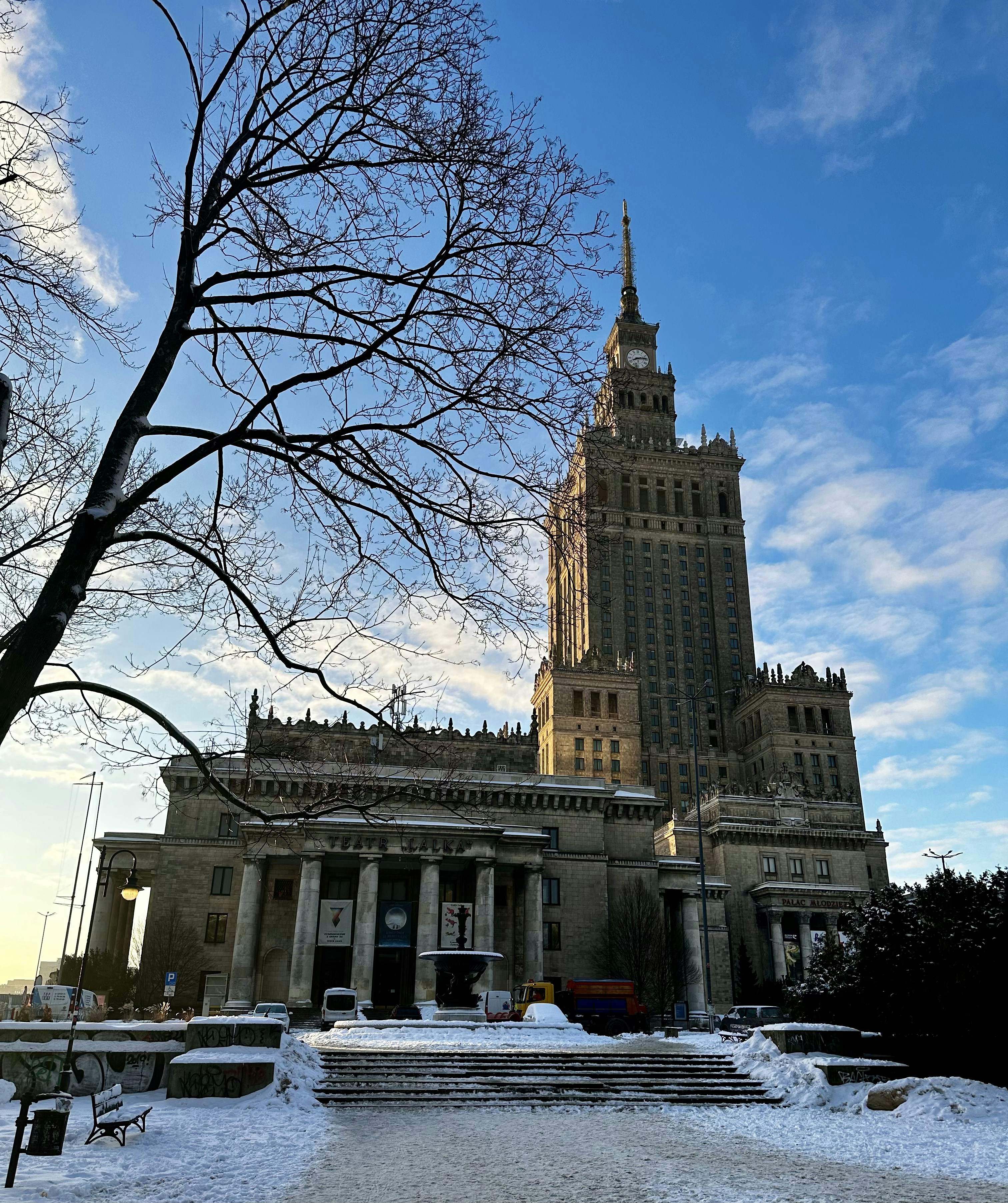 a very tall building with a clock tower in the background