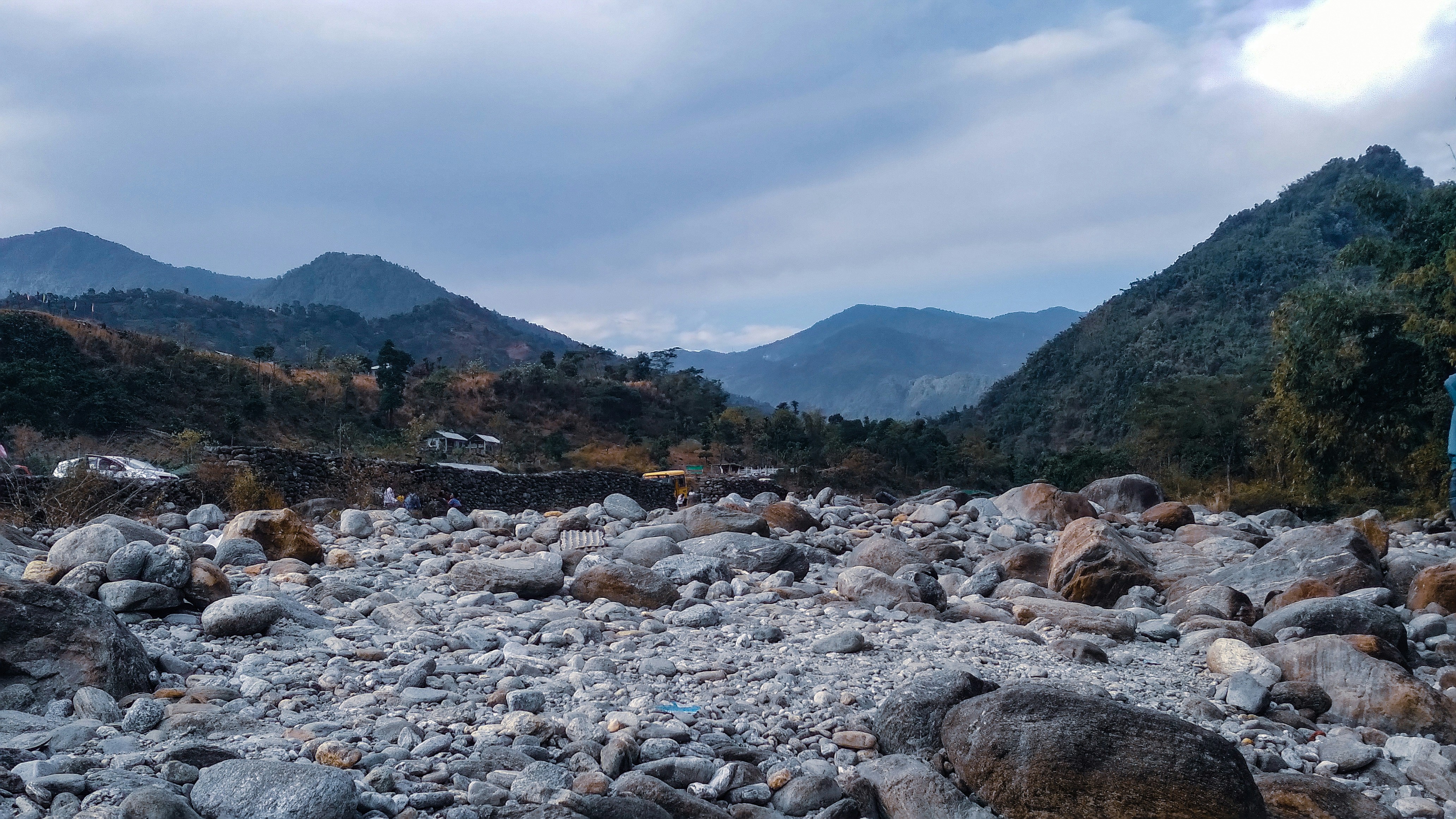 A man standing on top of a pile of rocks photo – Free Gorubathan picnic ...