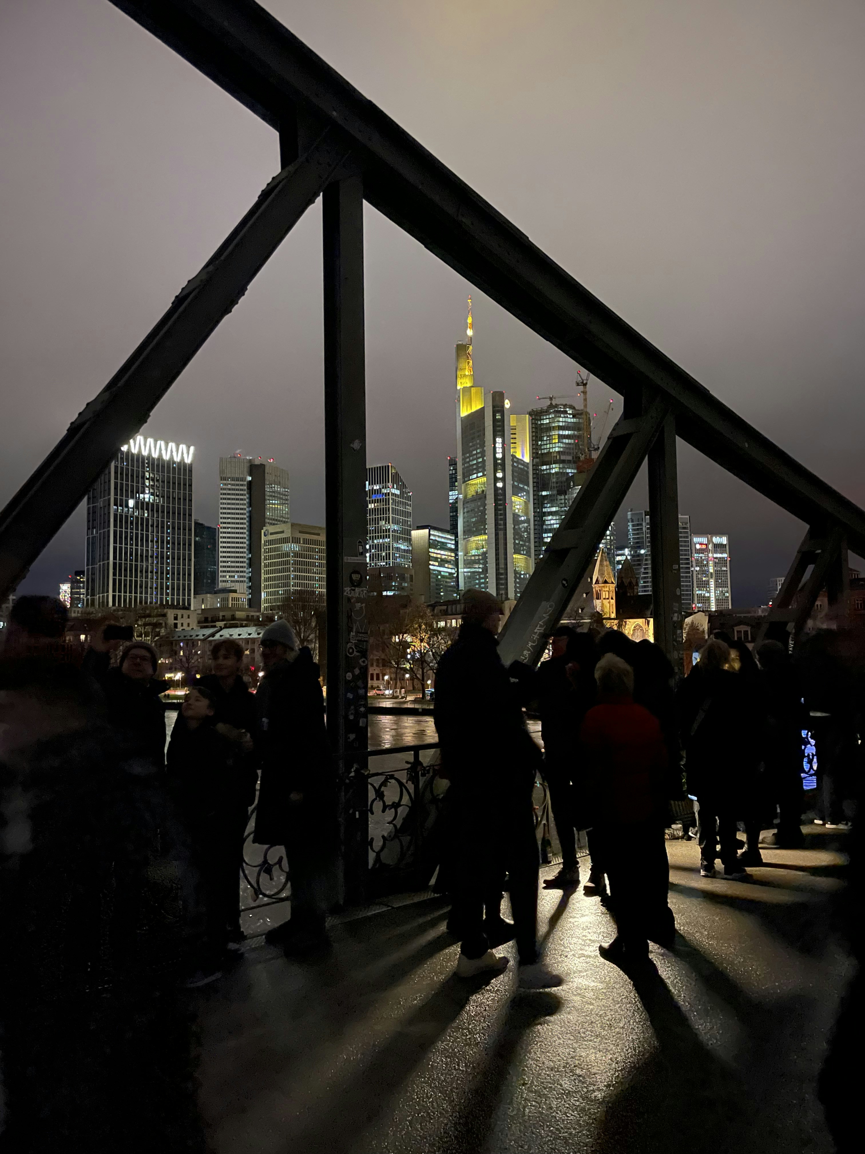 Night Crossing: silhouettes and skyline through a steel silhouette