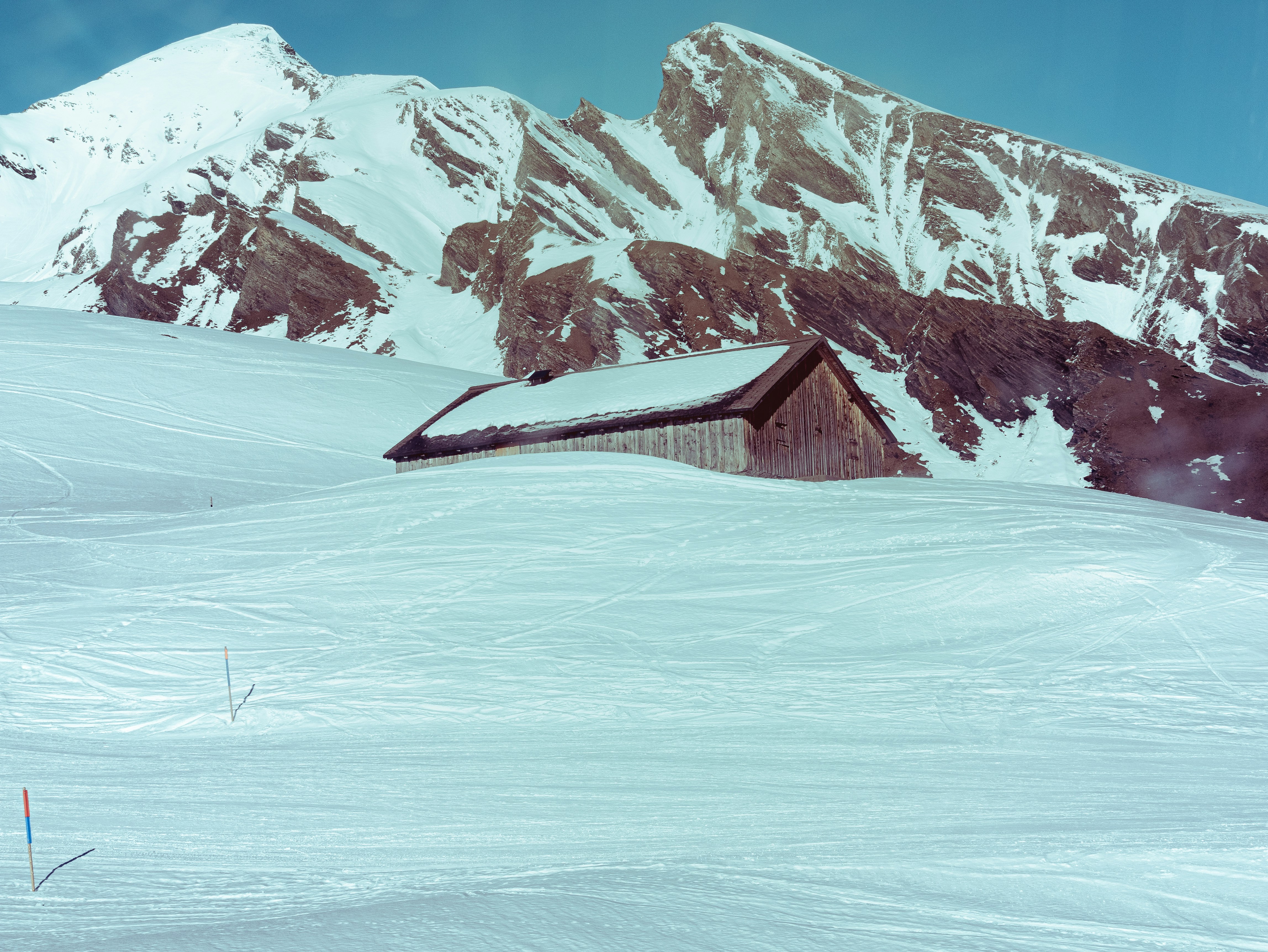 Snowbound Shelter at the Foot of Alpine Giants