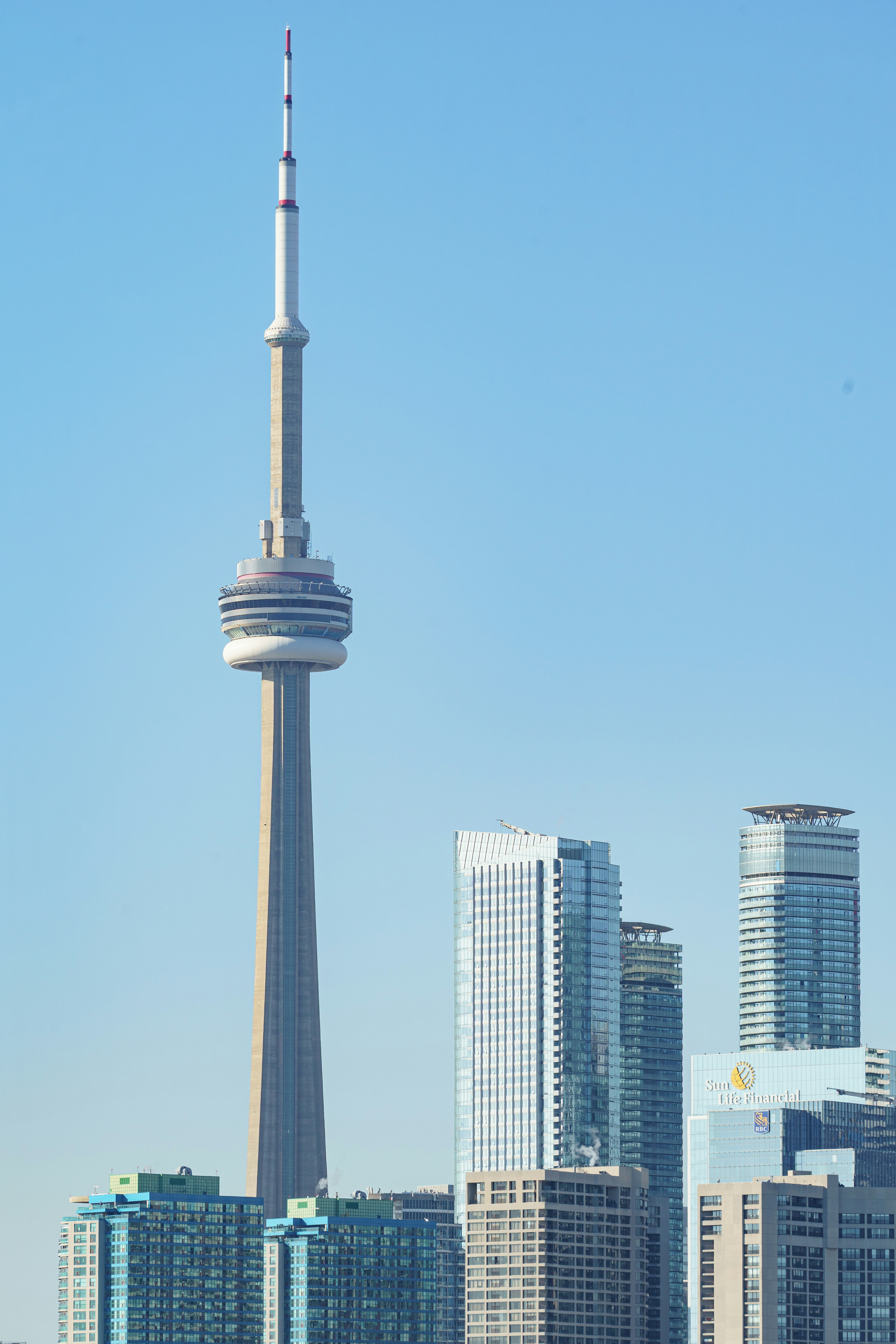 A city with a very tall tower in the middle of it photo – Free Blue ...