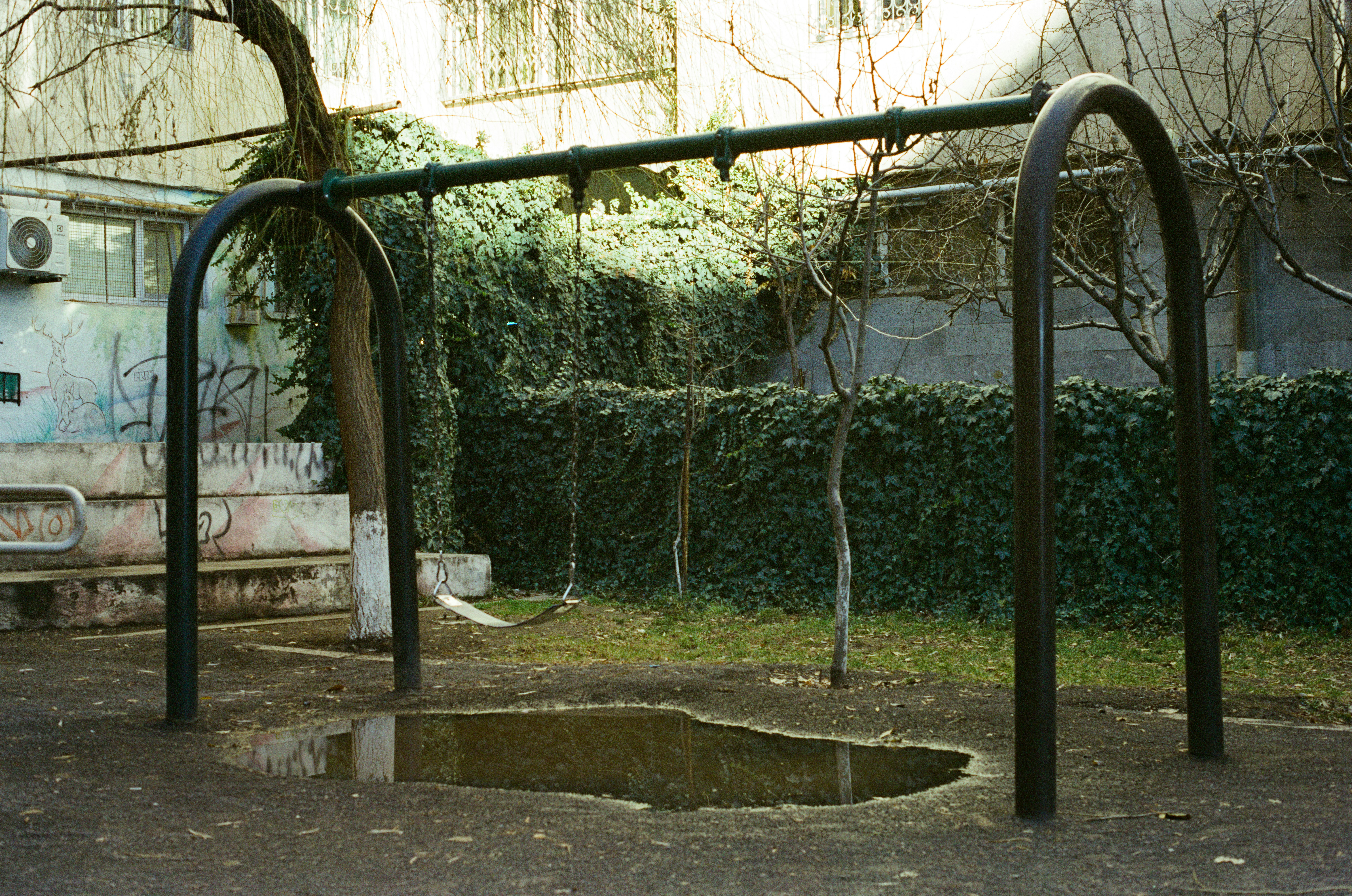 A playground with a puddle in the middle of it photo – Free Yerevan ...