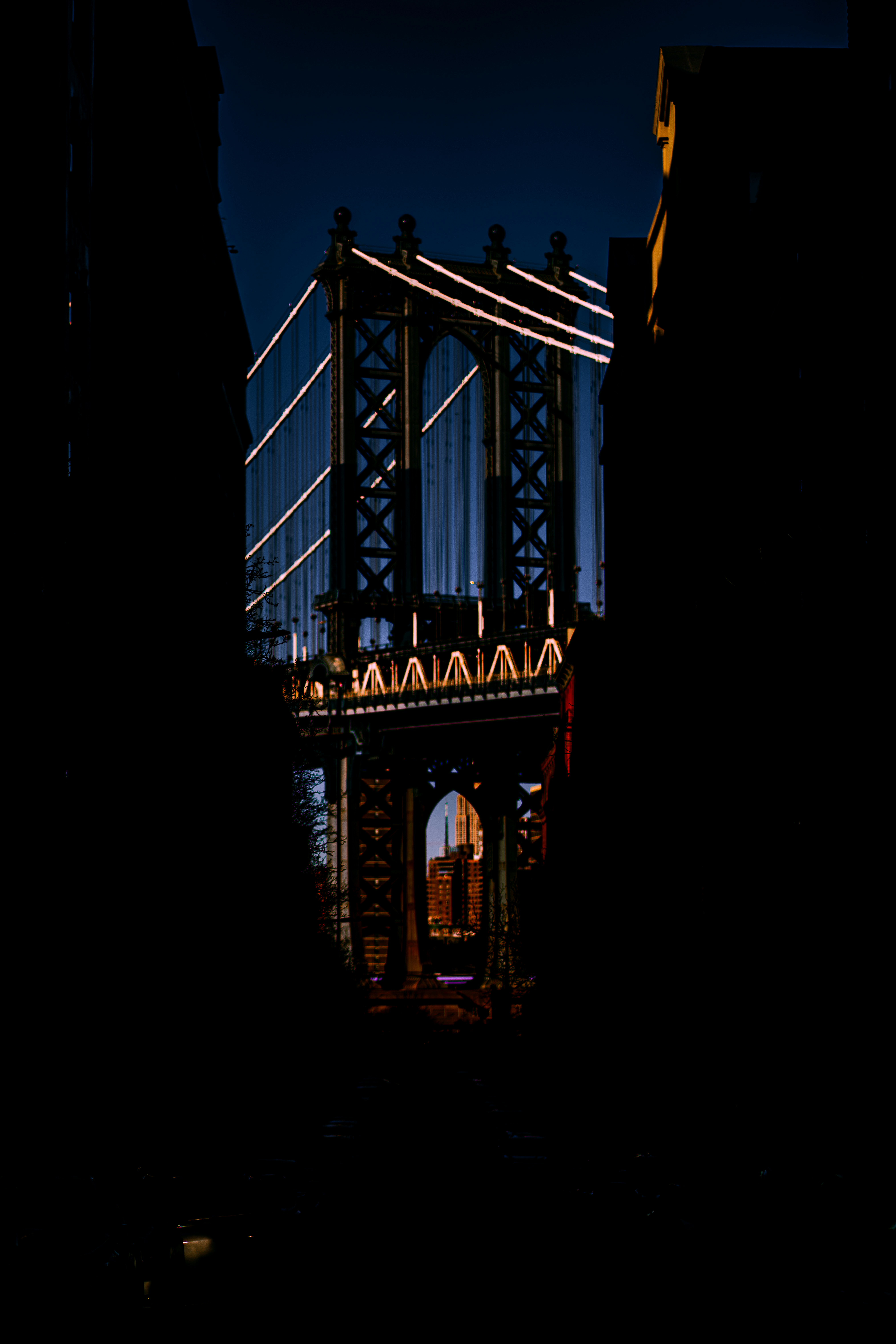 Blue Hour Bridge Framed by Shadowed Alleys