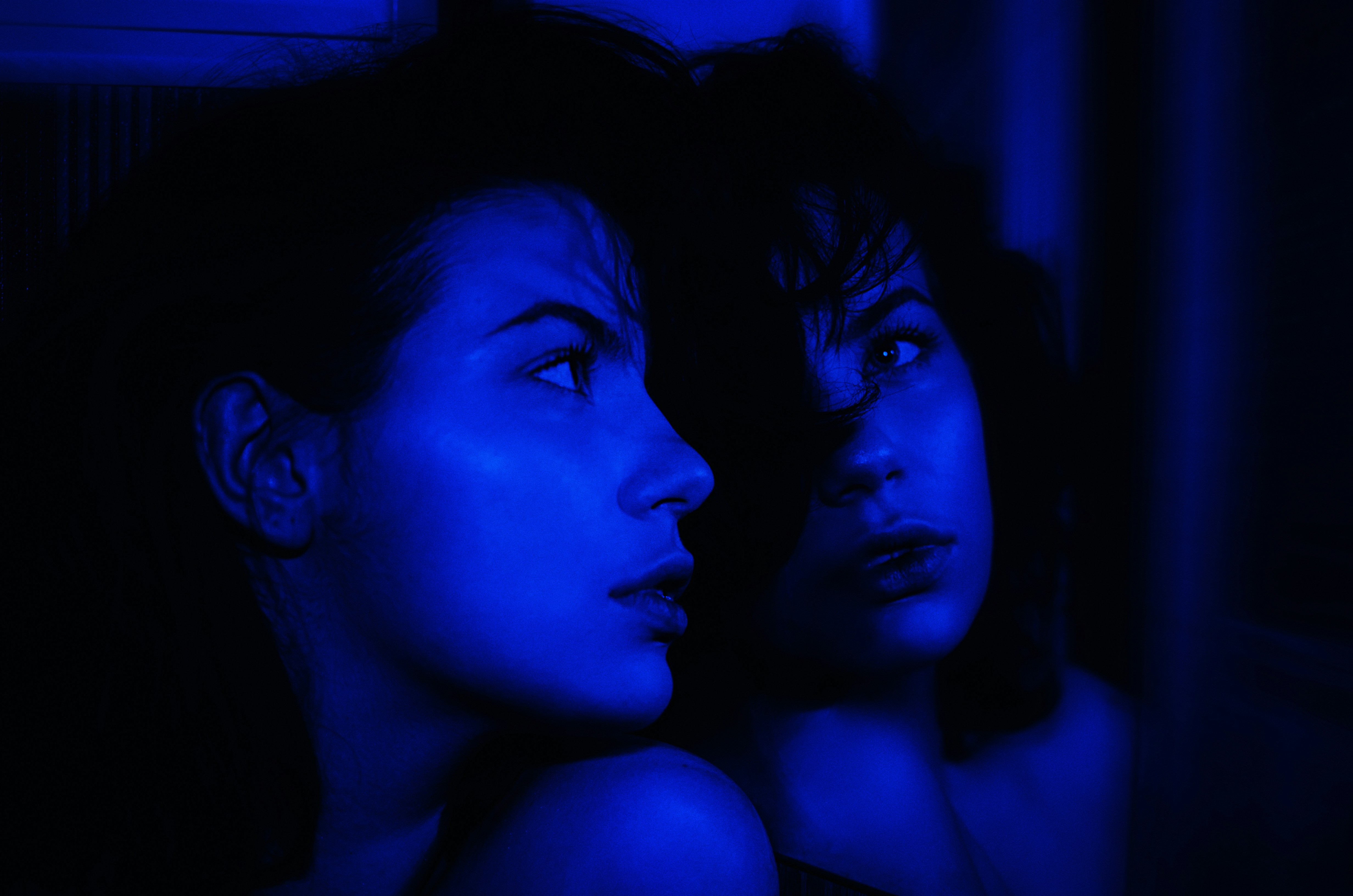 Blue Echo: A Dual Portrait Bathed in Neon Night