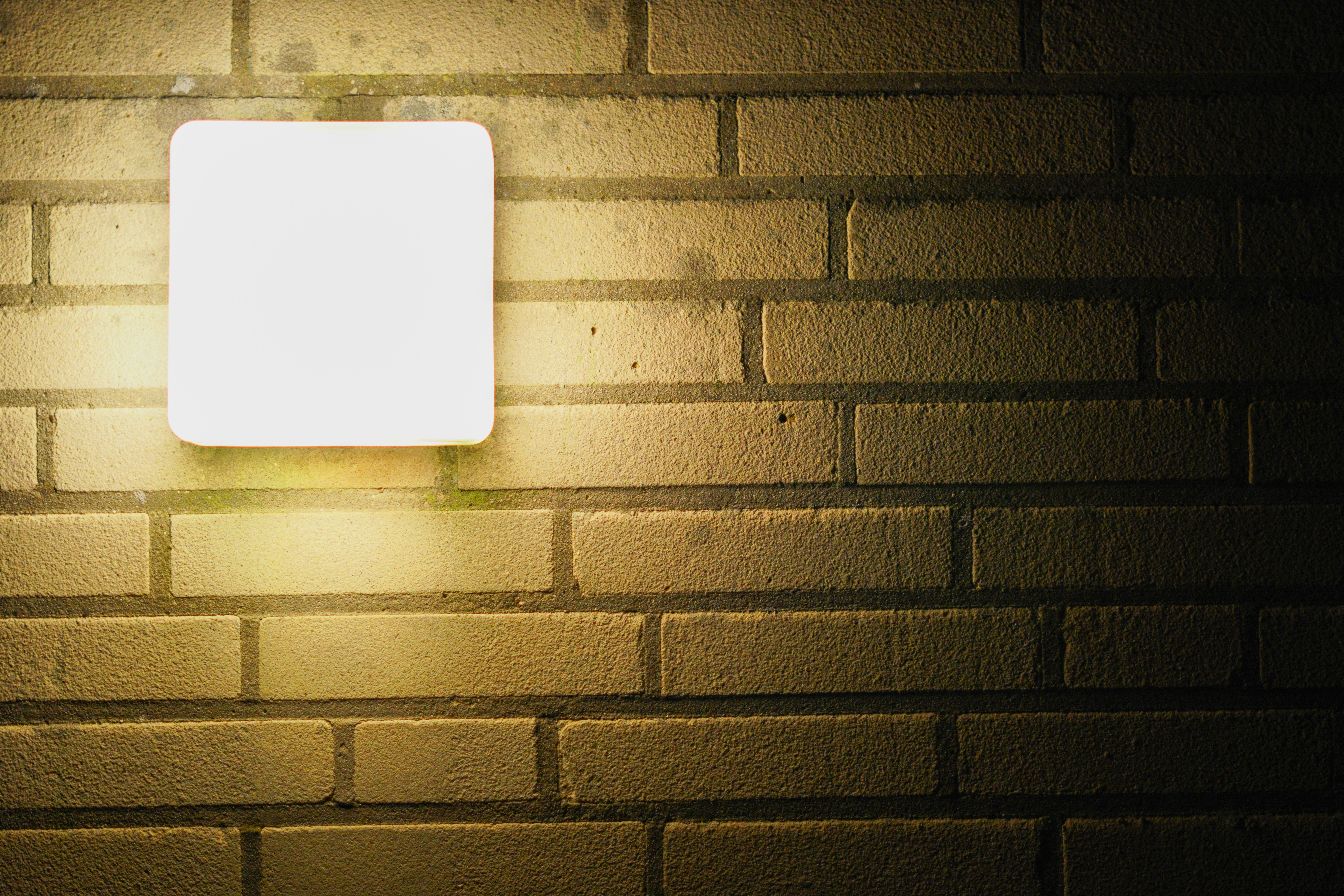 A brick wall with a square light on it photo – Free Brick Image on Unsplash