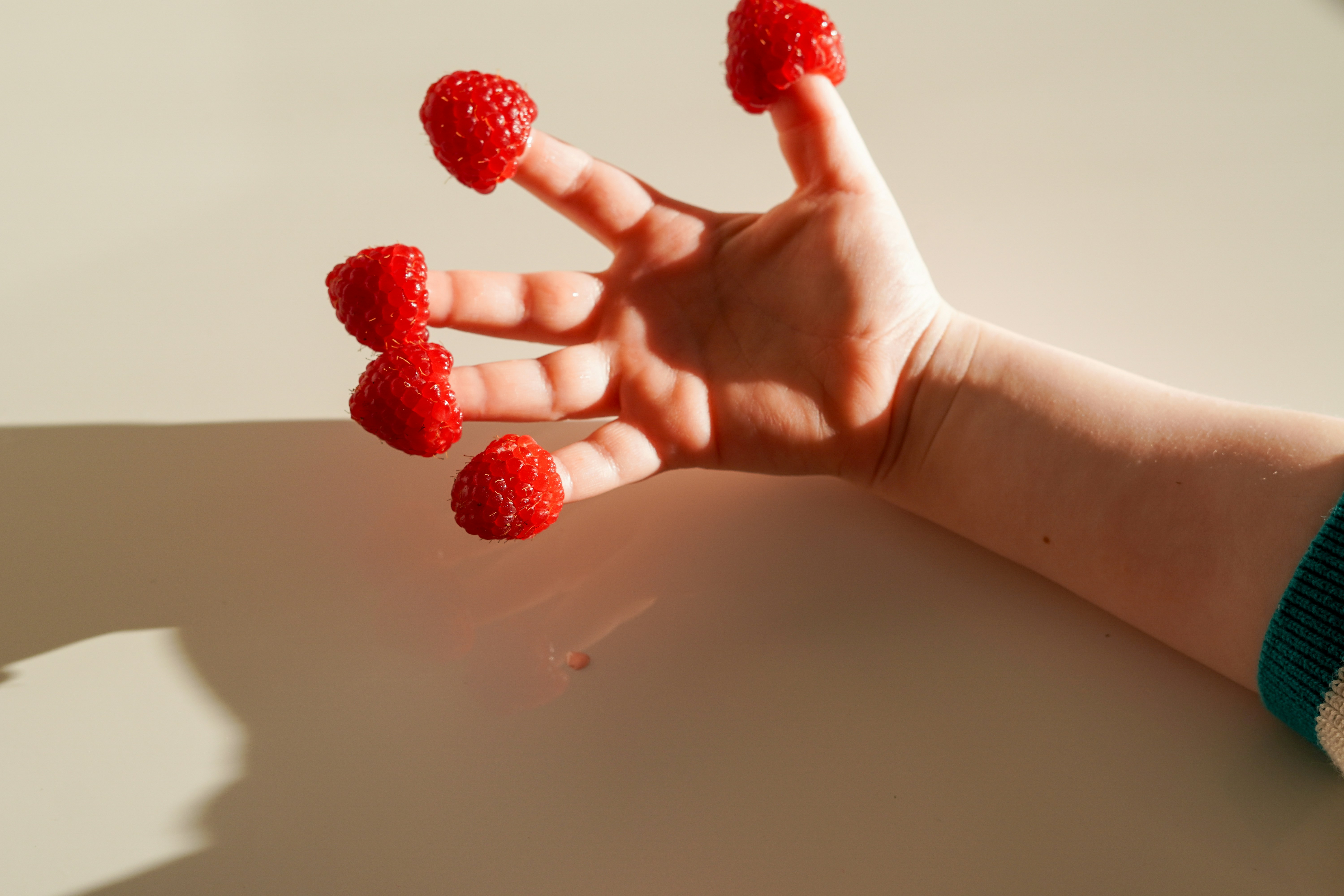 Sunlit Raspberry Grasp: A Tiny Handful of Summer Reds