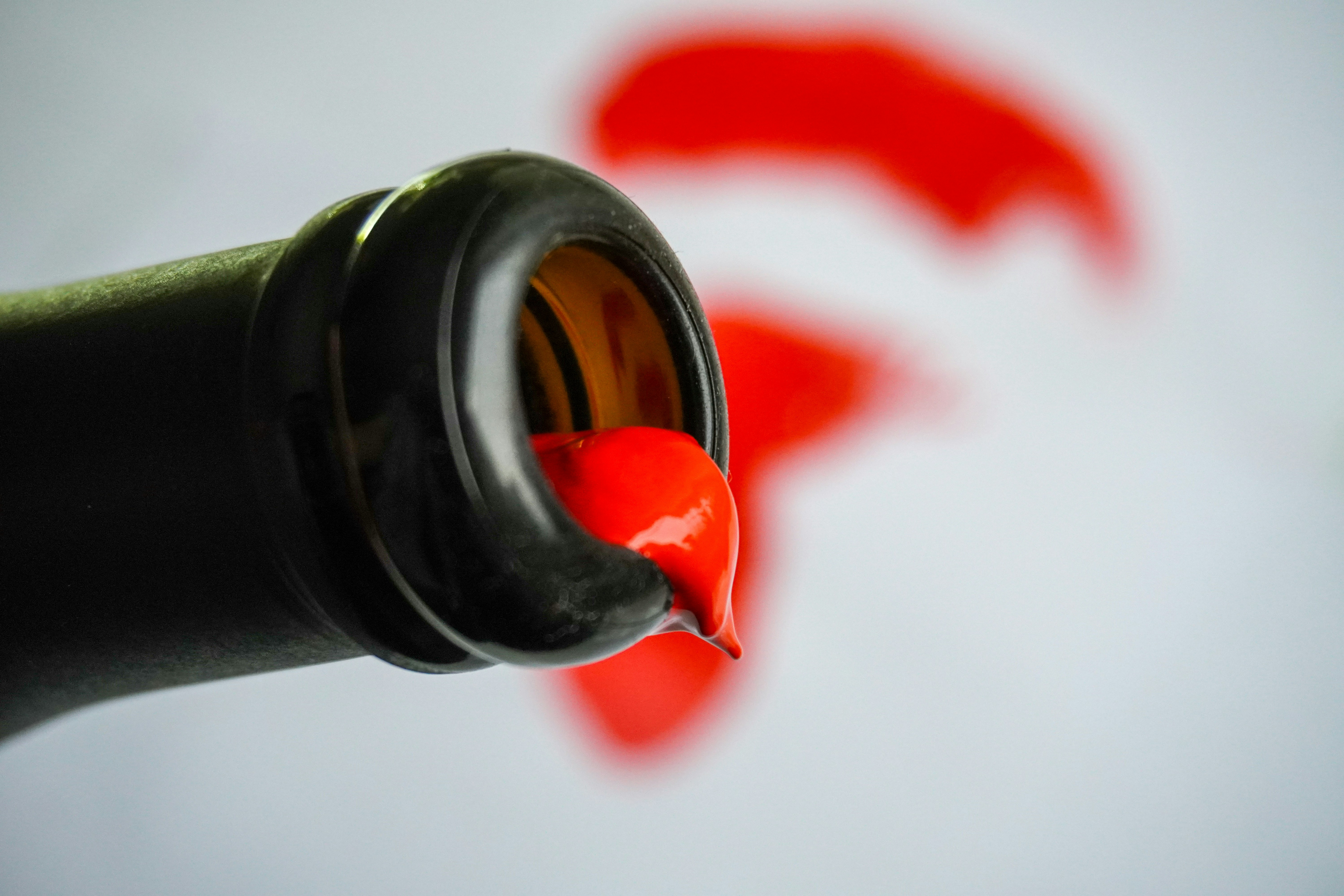 Lip of Red: A Macro Study of a Pouring Bottle