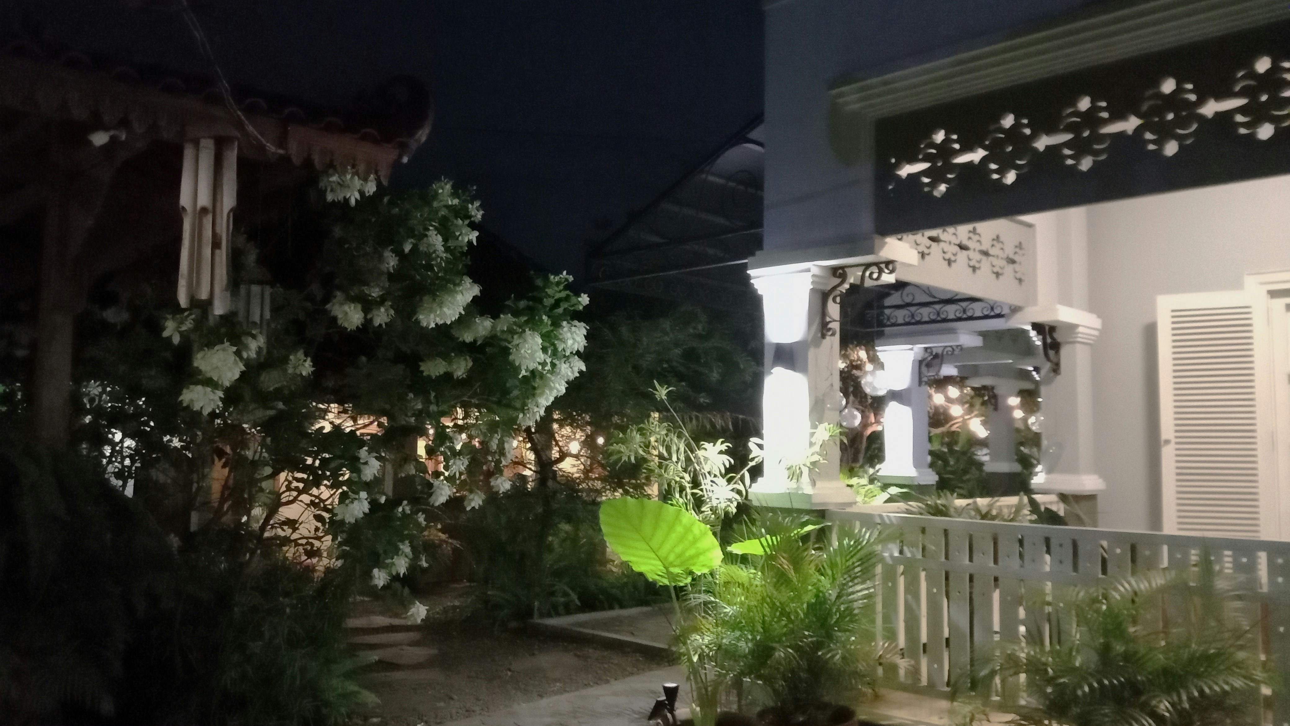 Warm Lanterns on a Quiet Veranda, Framed by Night Garden