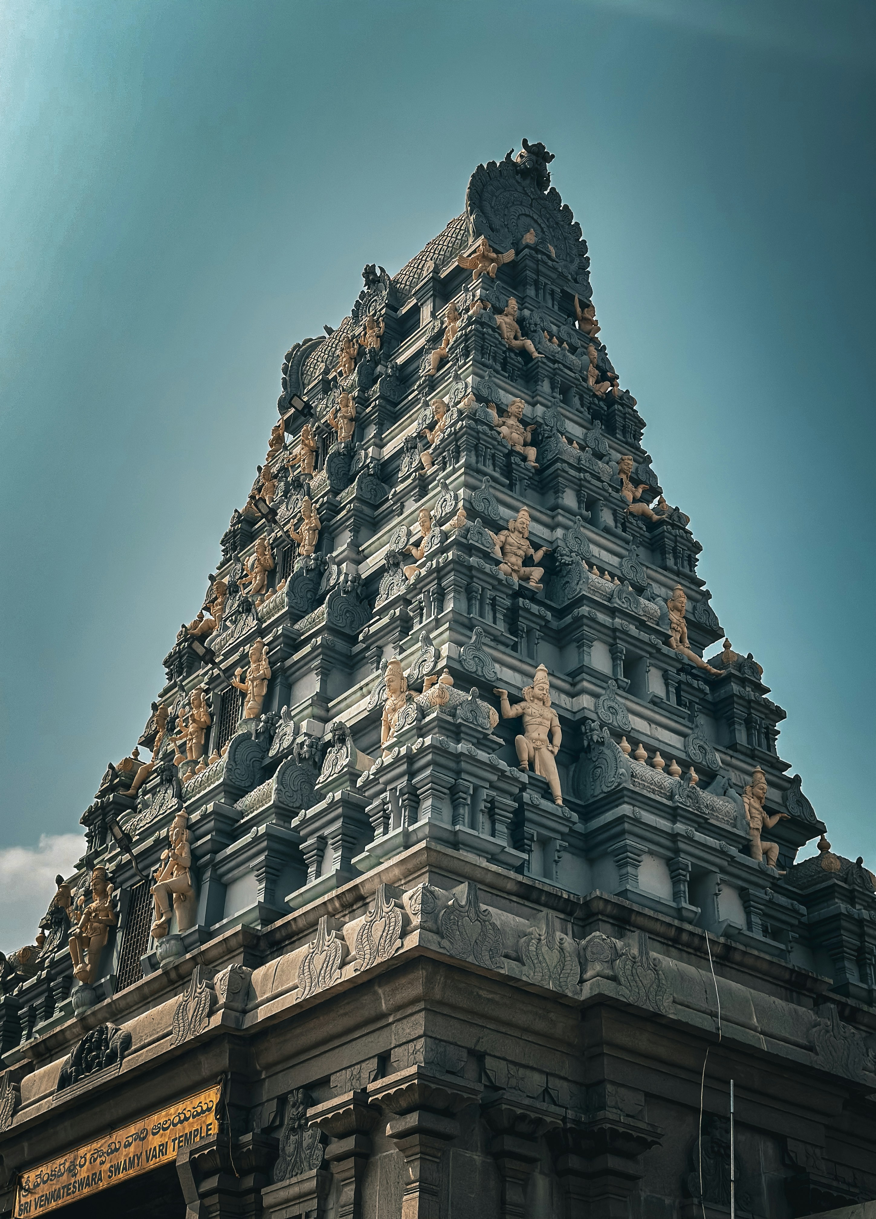 A tall tower with statues on top of it photo – Free Architecture Image ...