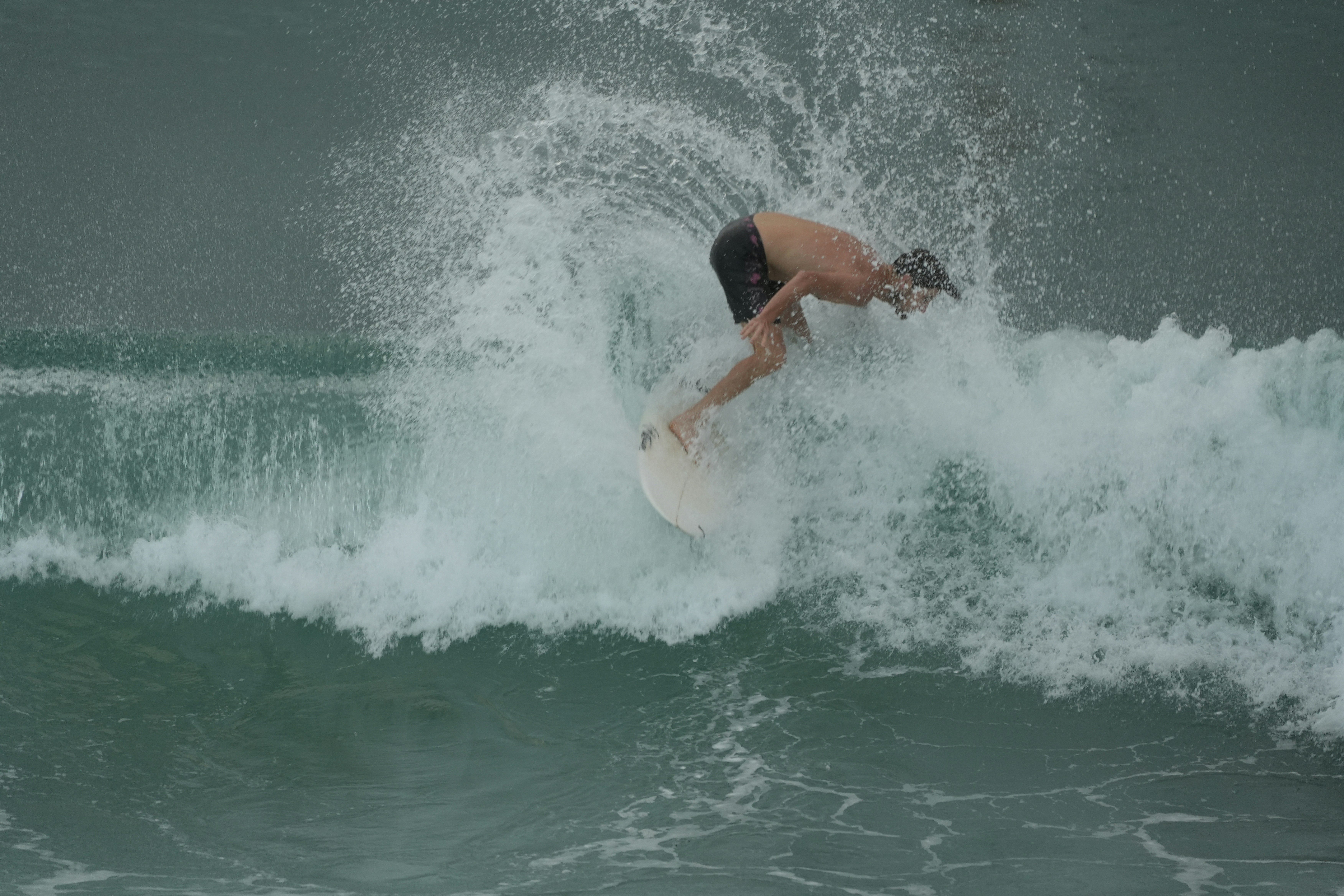 Airborne Carve Over a Turquoise Shorebreak