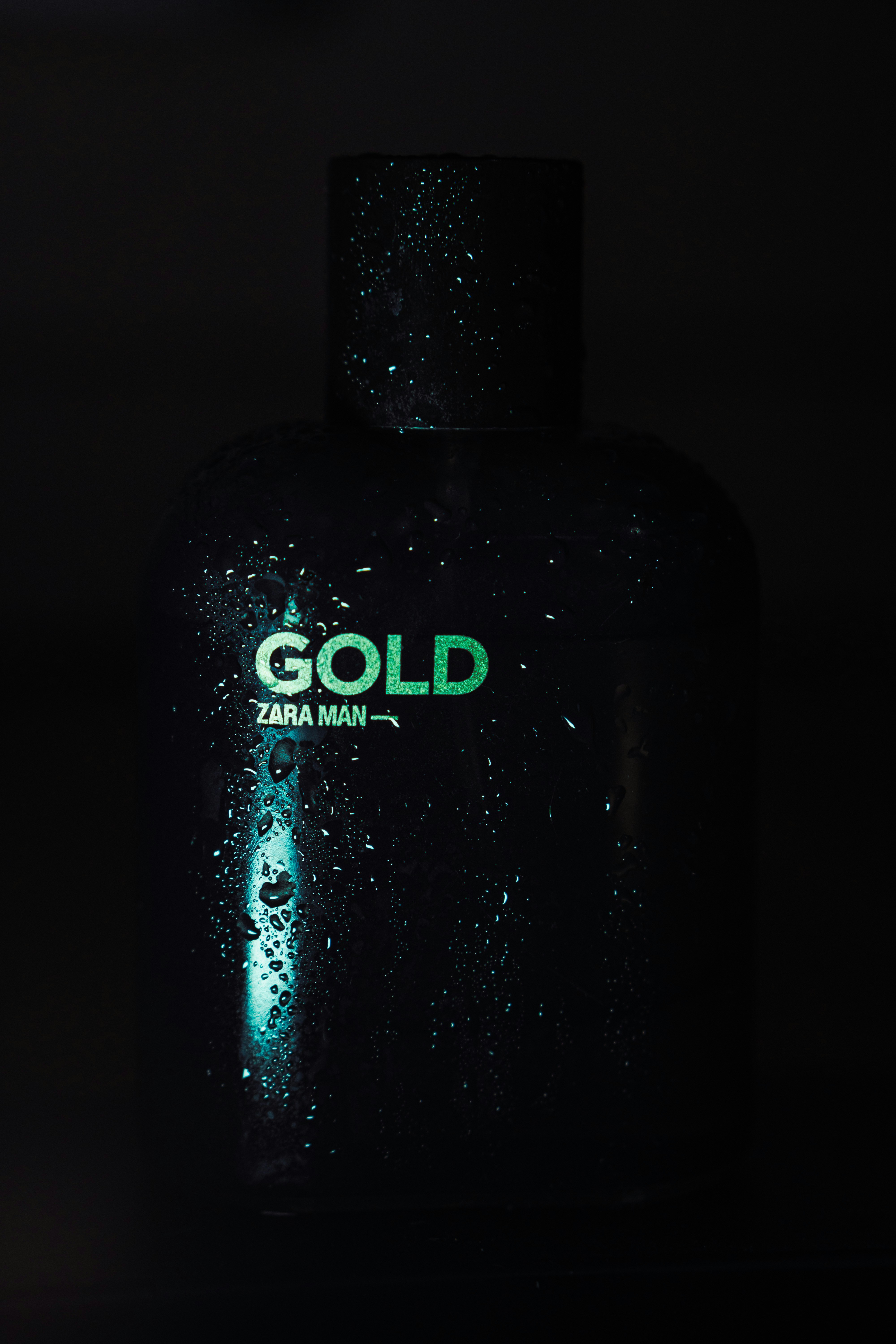 a close up of a bottle of water in the dark