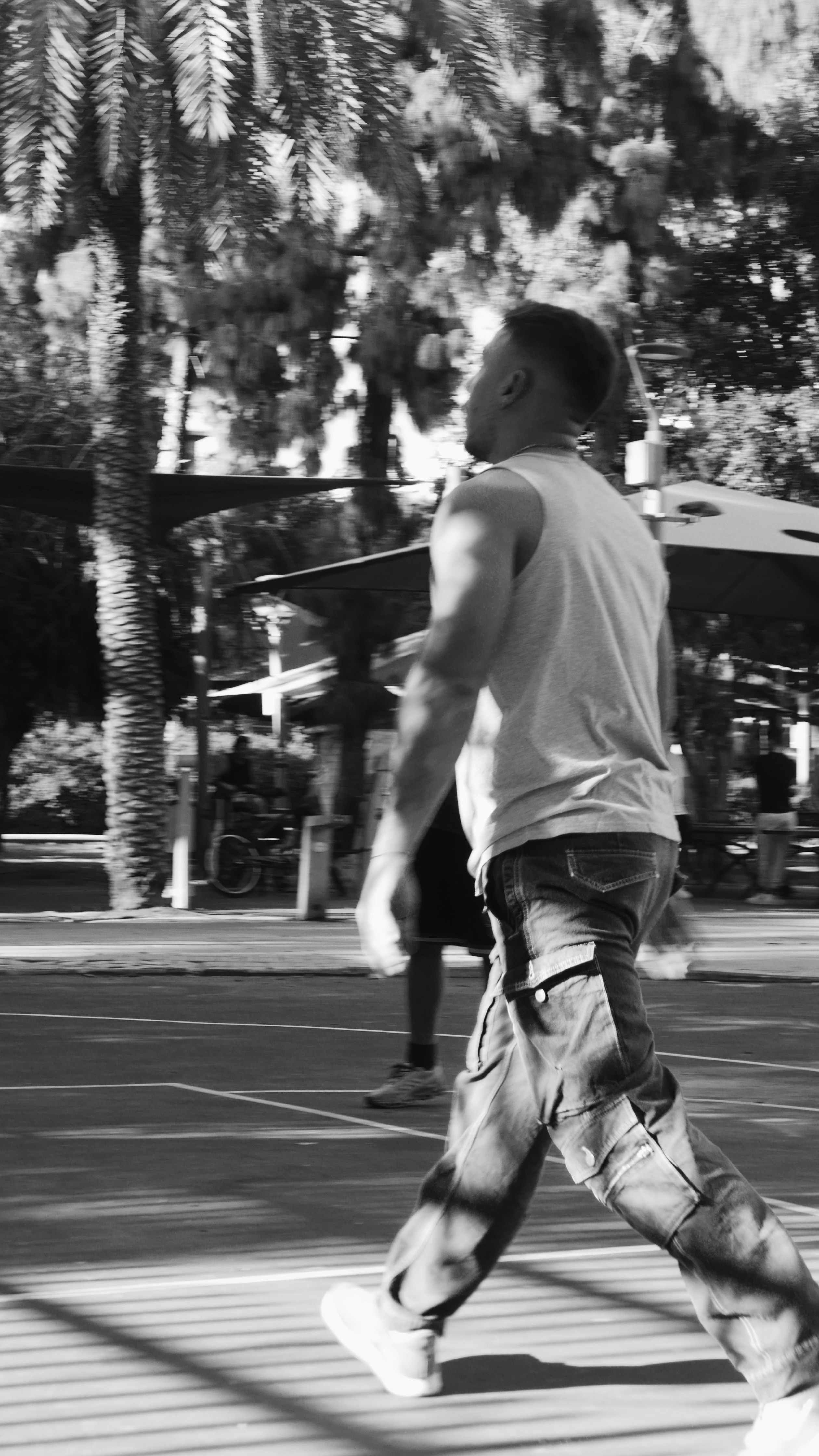 A black and white photo of a man walking photo – Free Man Image on Unsplash