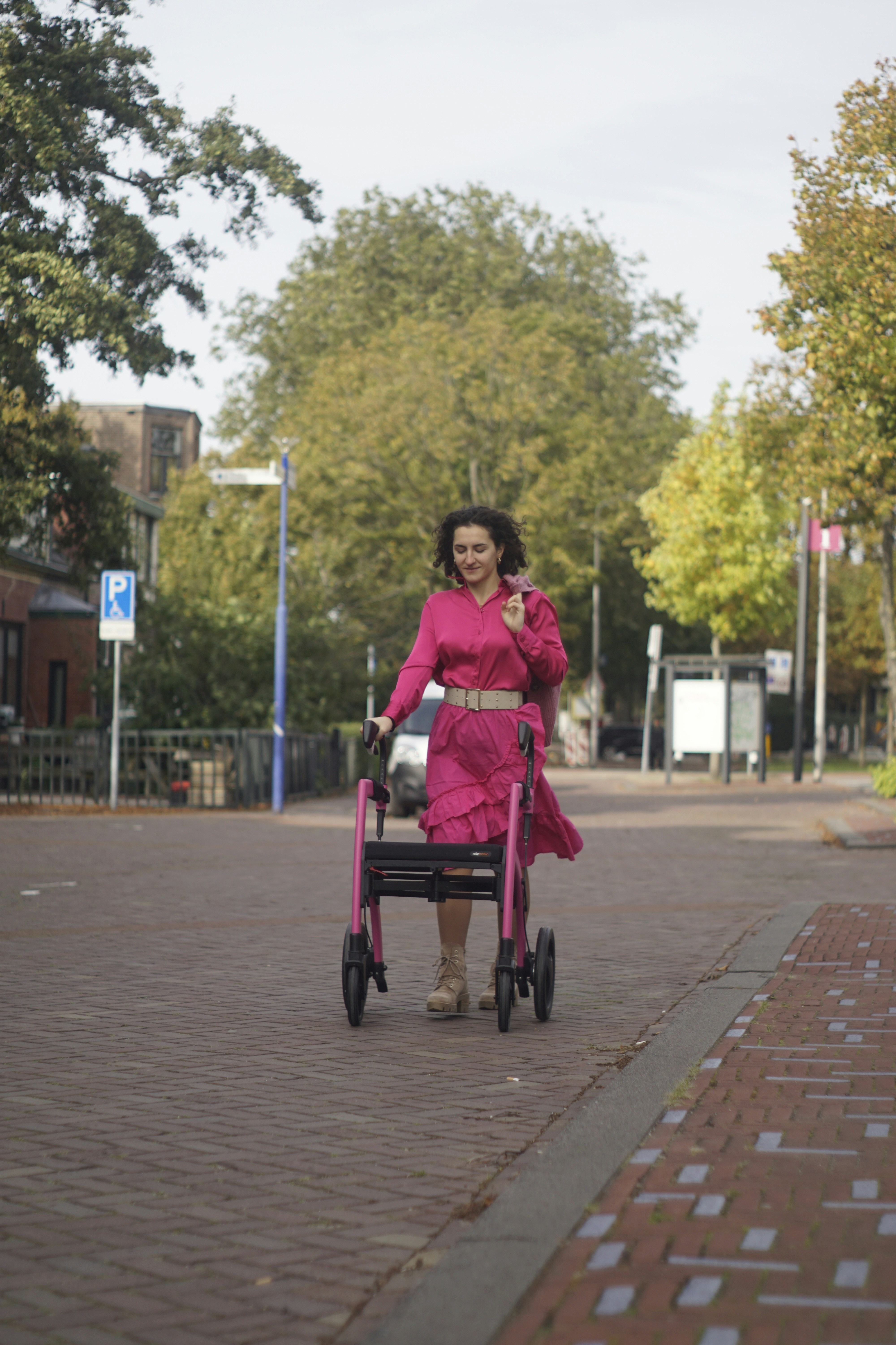 A woman in a pink dress pushing a stroller photo – Free Vehicle Image ...
