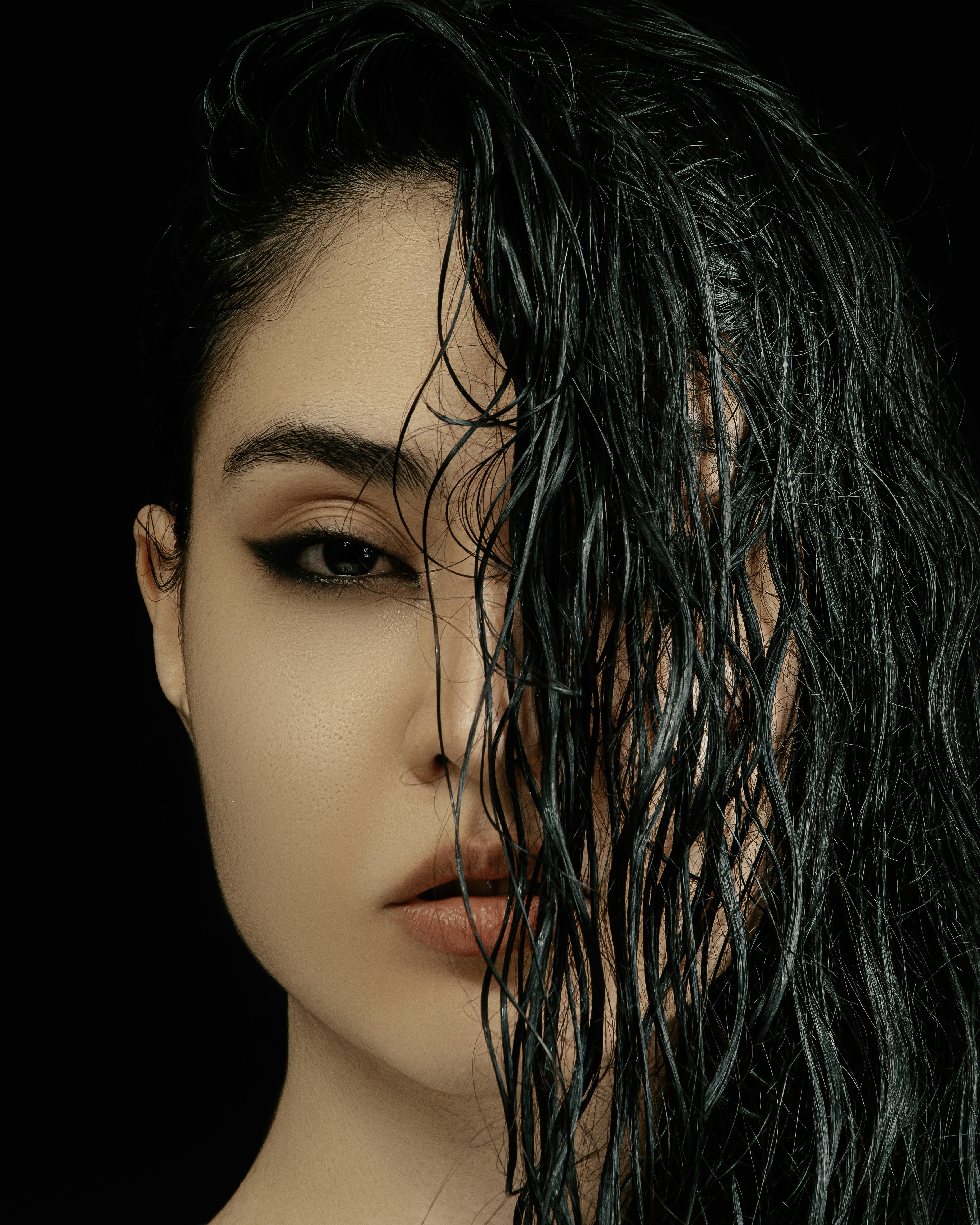 Veiled Gaze: A Close-Up Portrait with Wet Strands