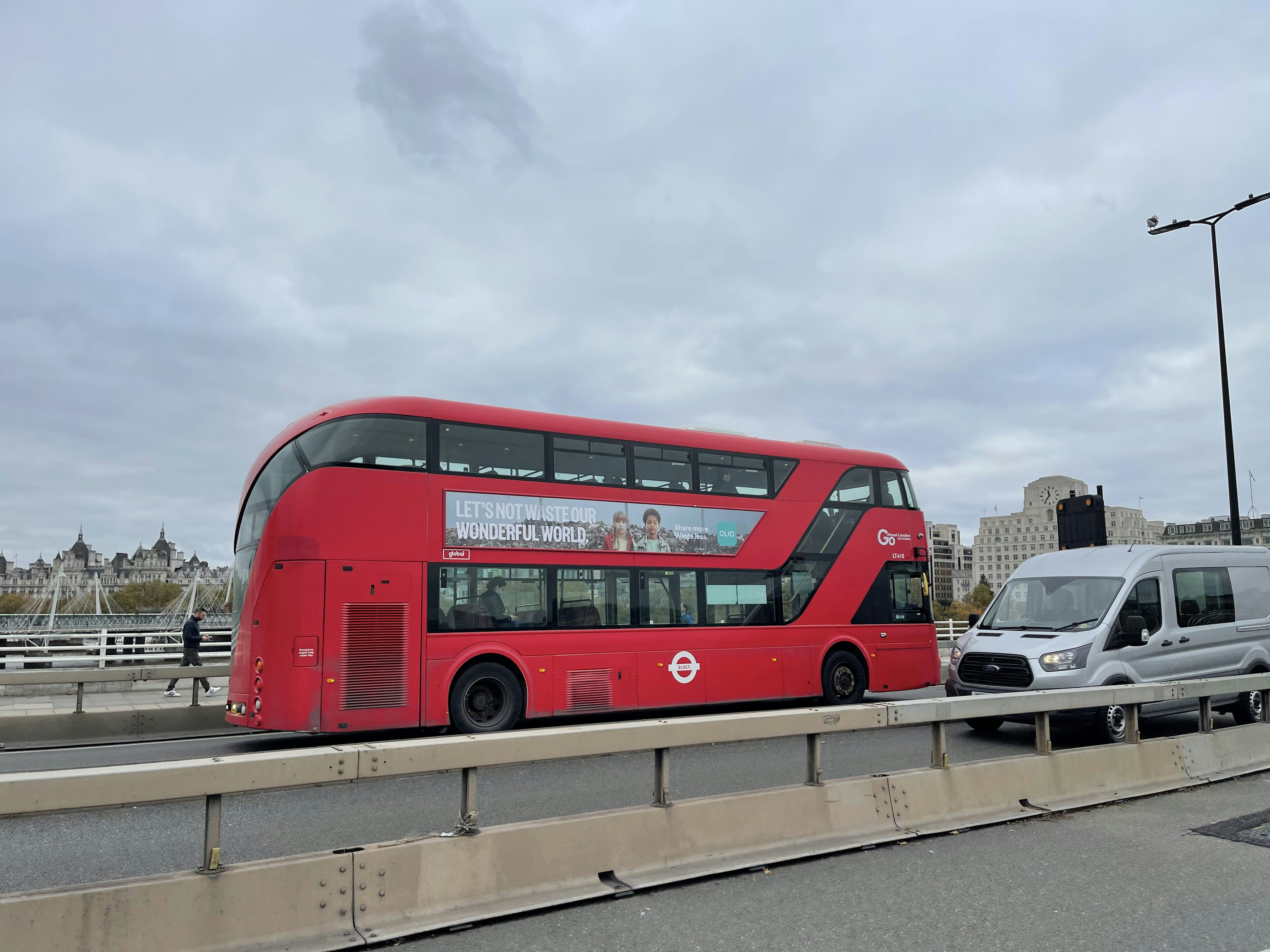 A red double decker bus driving down a street photo – Free Road Image ...