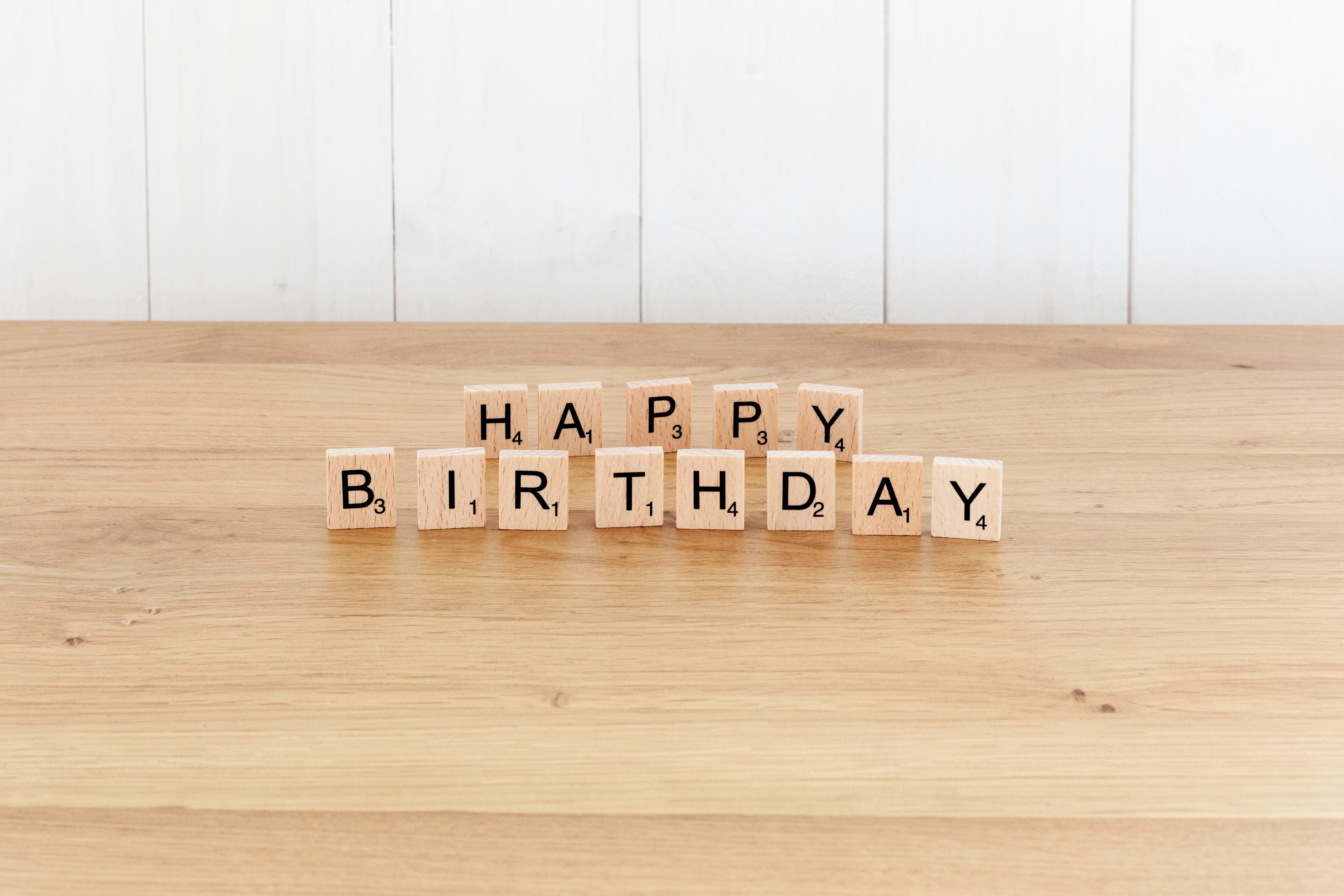 A wooden block spelling happy birthday on a table photo – Free Birthday ...