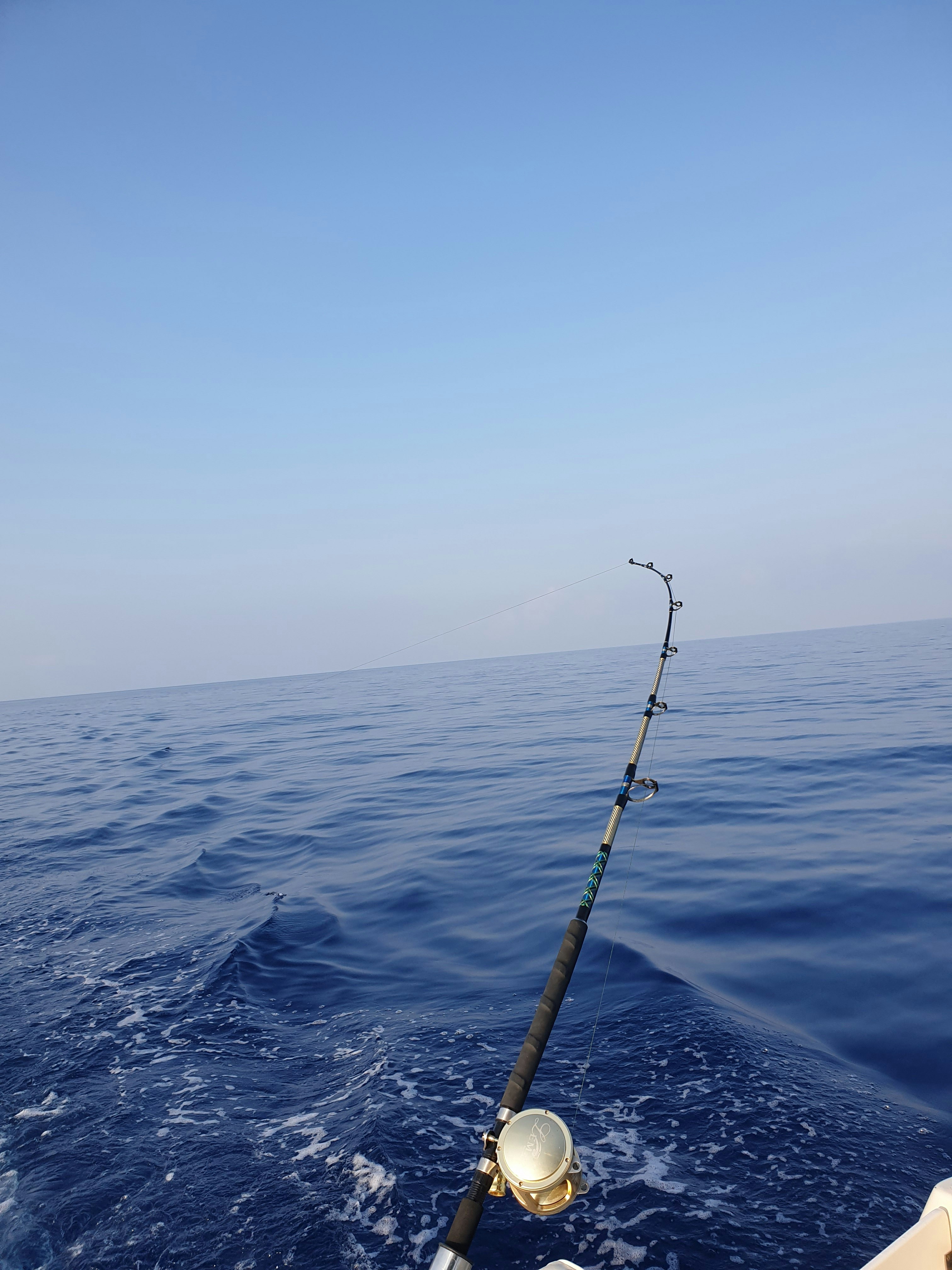 A fishing rod on a boat in the ocean photo – Free Blue Image on Unsplash