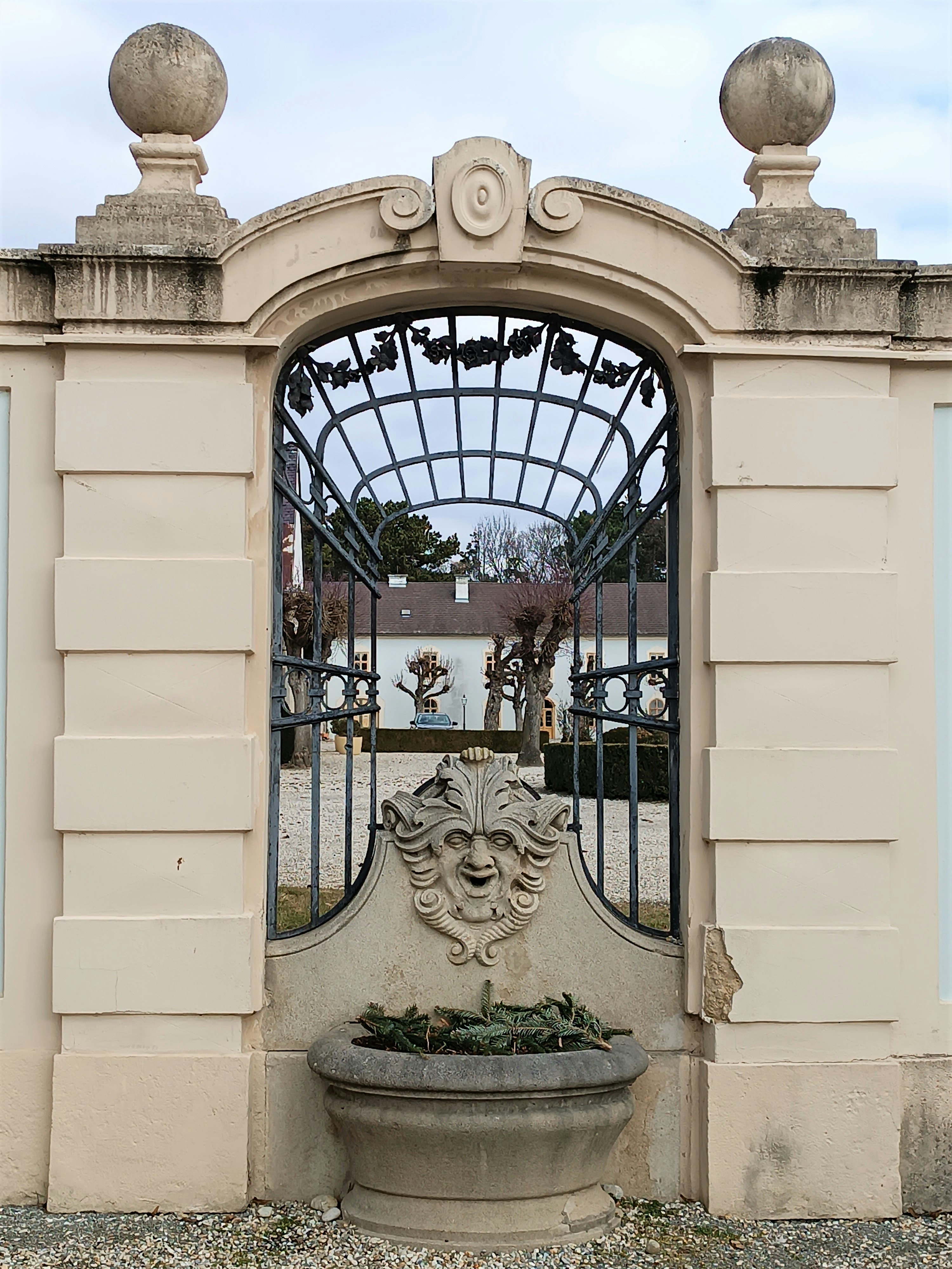 a gate with a fountain in front of it