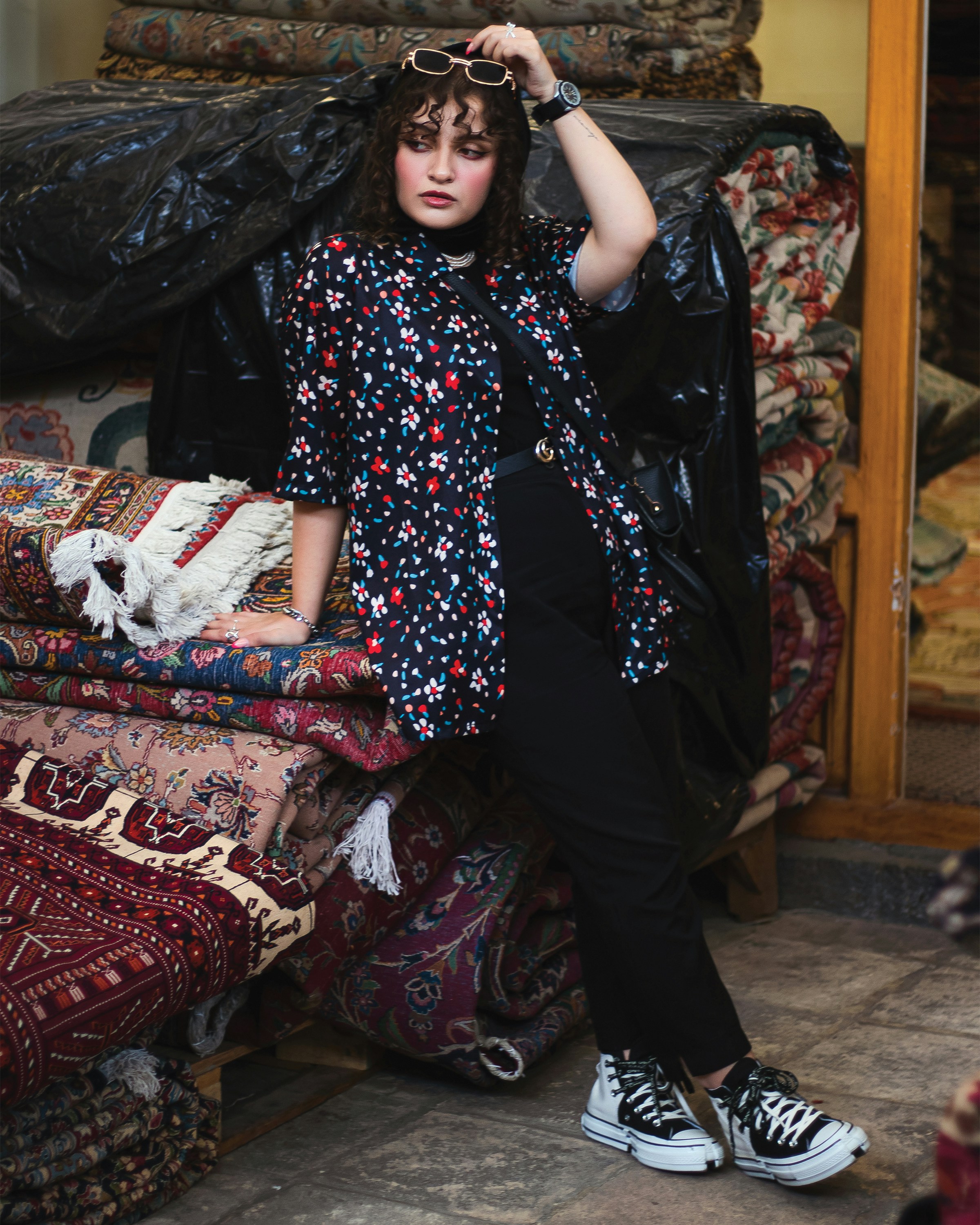 Patterned Confidence: A Casual Portrait amid Textile Backdrops