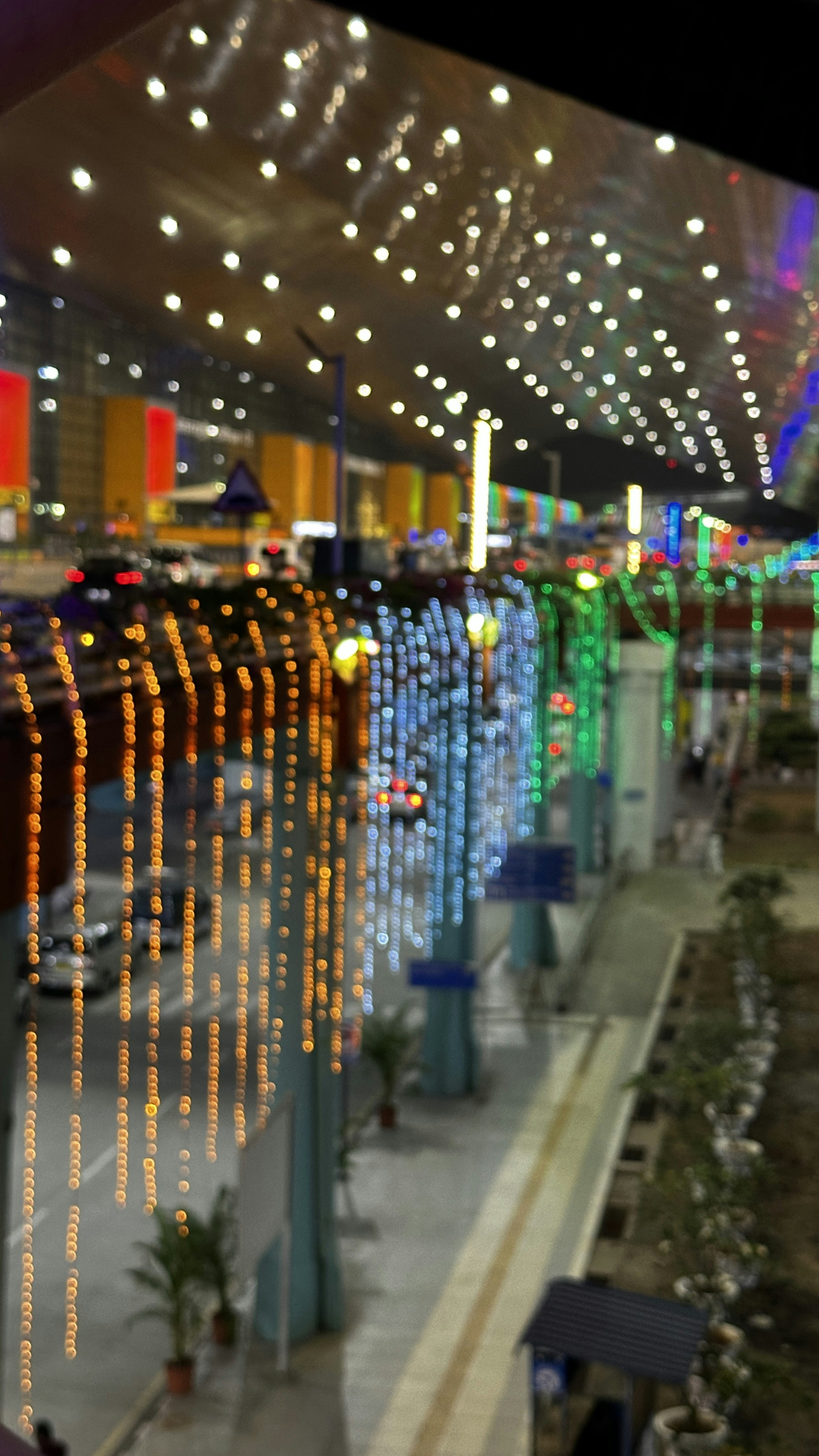 Lantern Veil Over a Neon Plaza: Night Lights Cascading Along a Modern Promenade