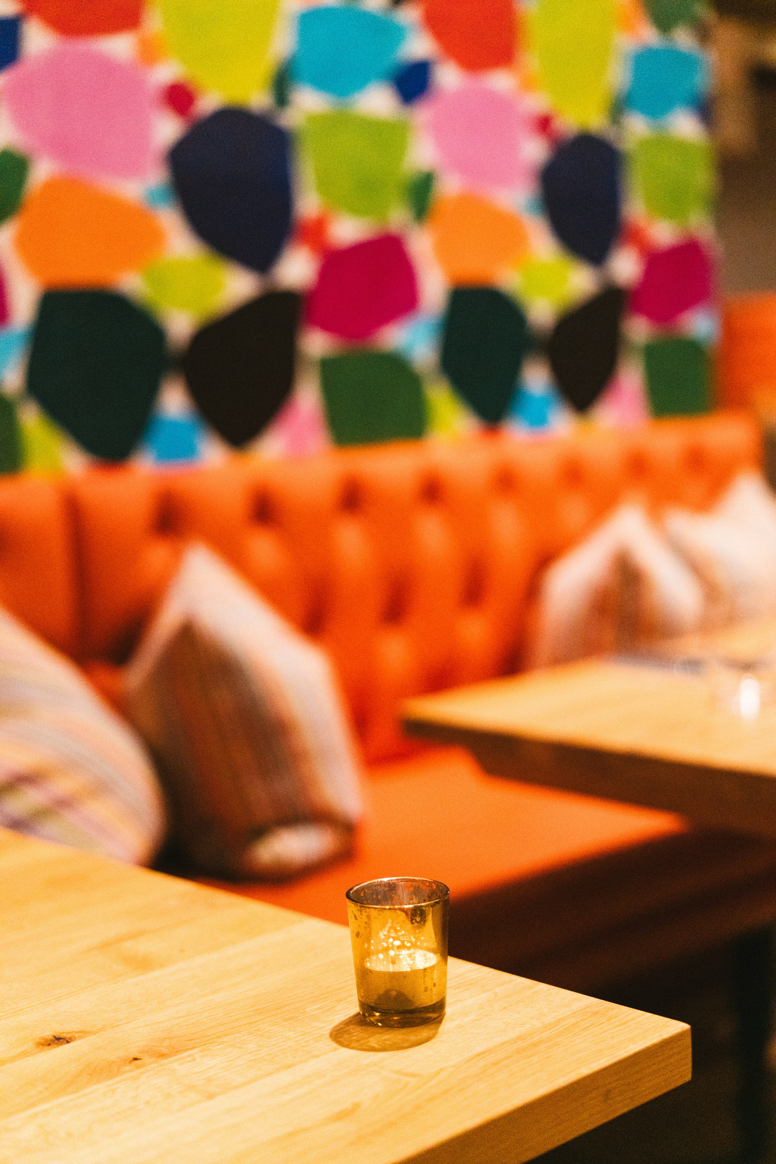 Amber Glass Beneath a Kaleidoscope Café Wall