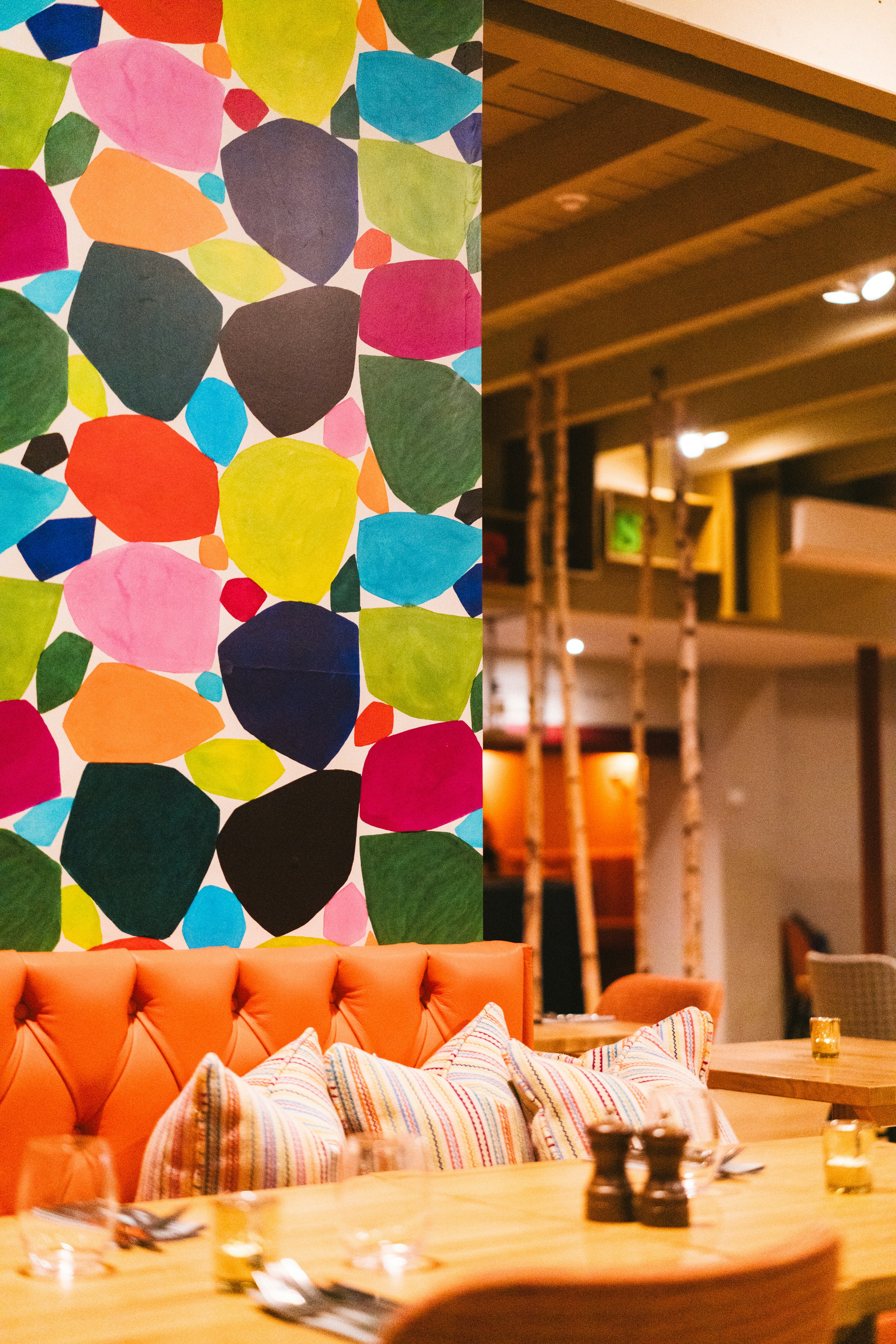 Vibrant Wall Meets Cozy Dining: A Colorful Wall Defines the Lounge