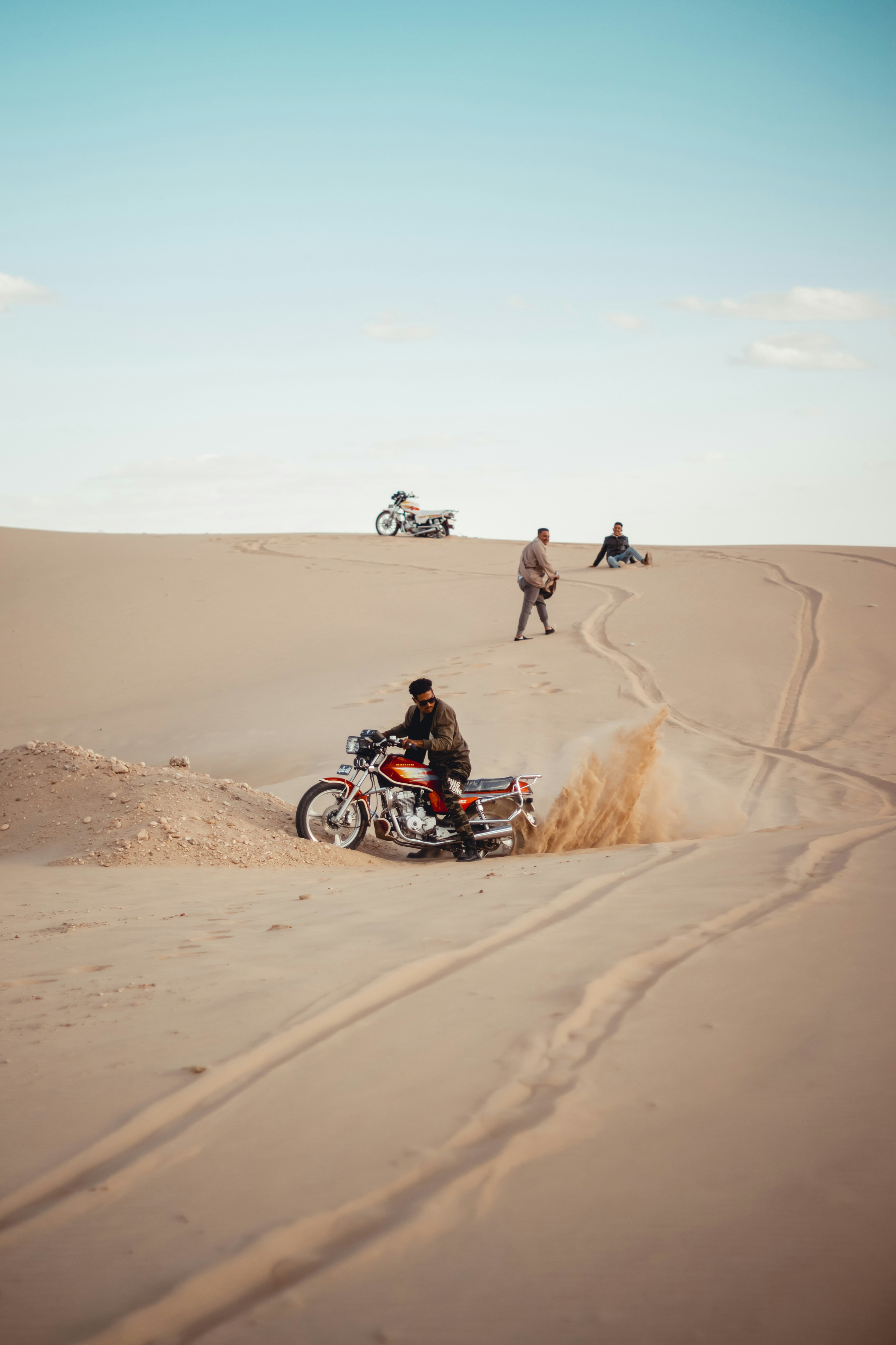 A person riding a motorcycle in the desert photo – Free Desert Image on ...