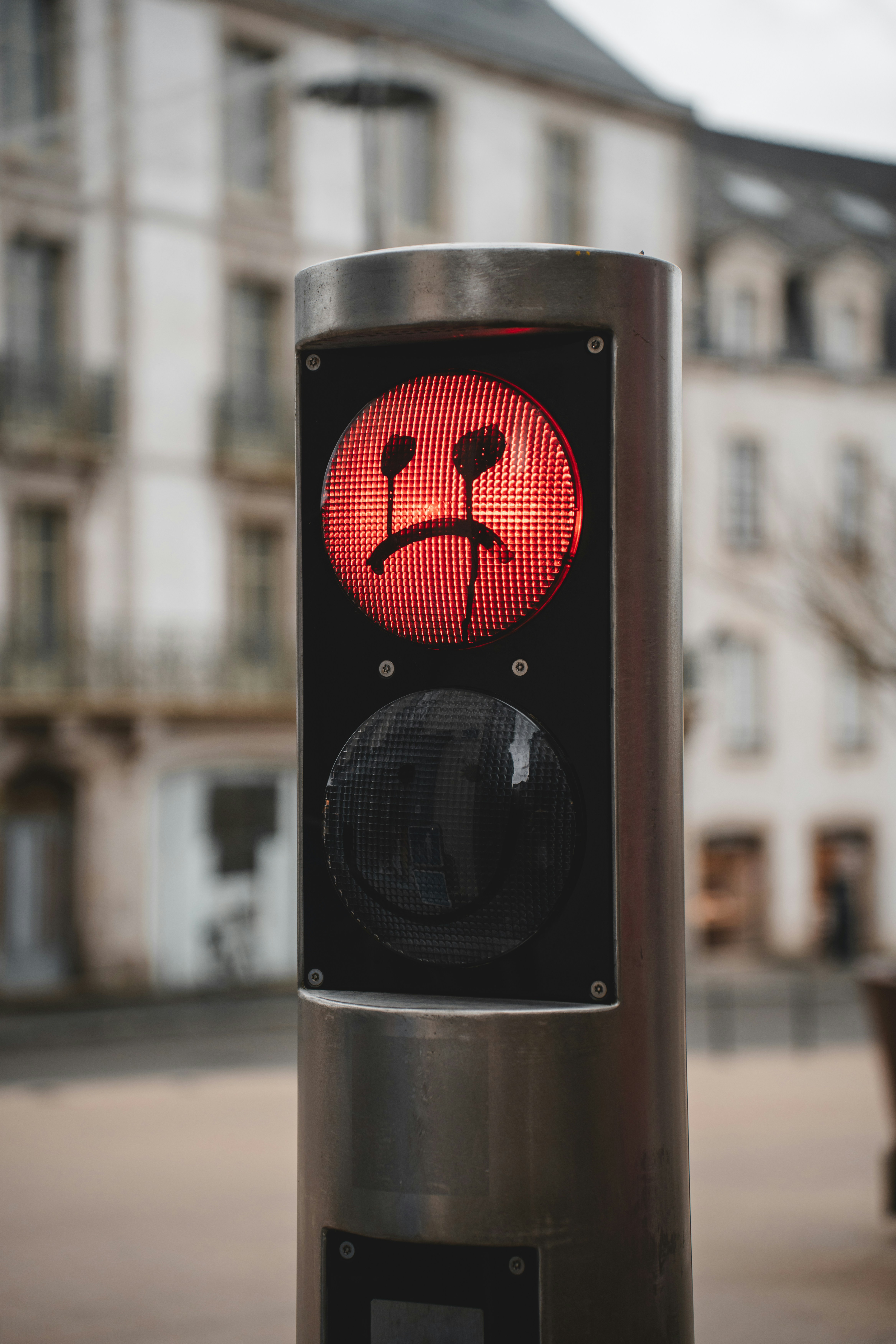 A traffic light with a sad face drawn on it photo – Free Light Image on ...