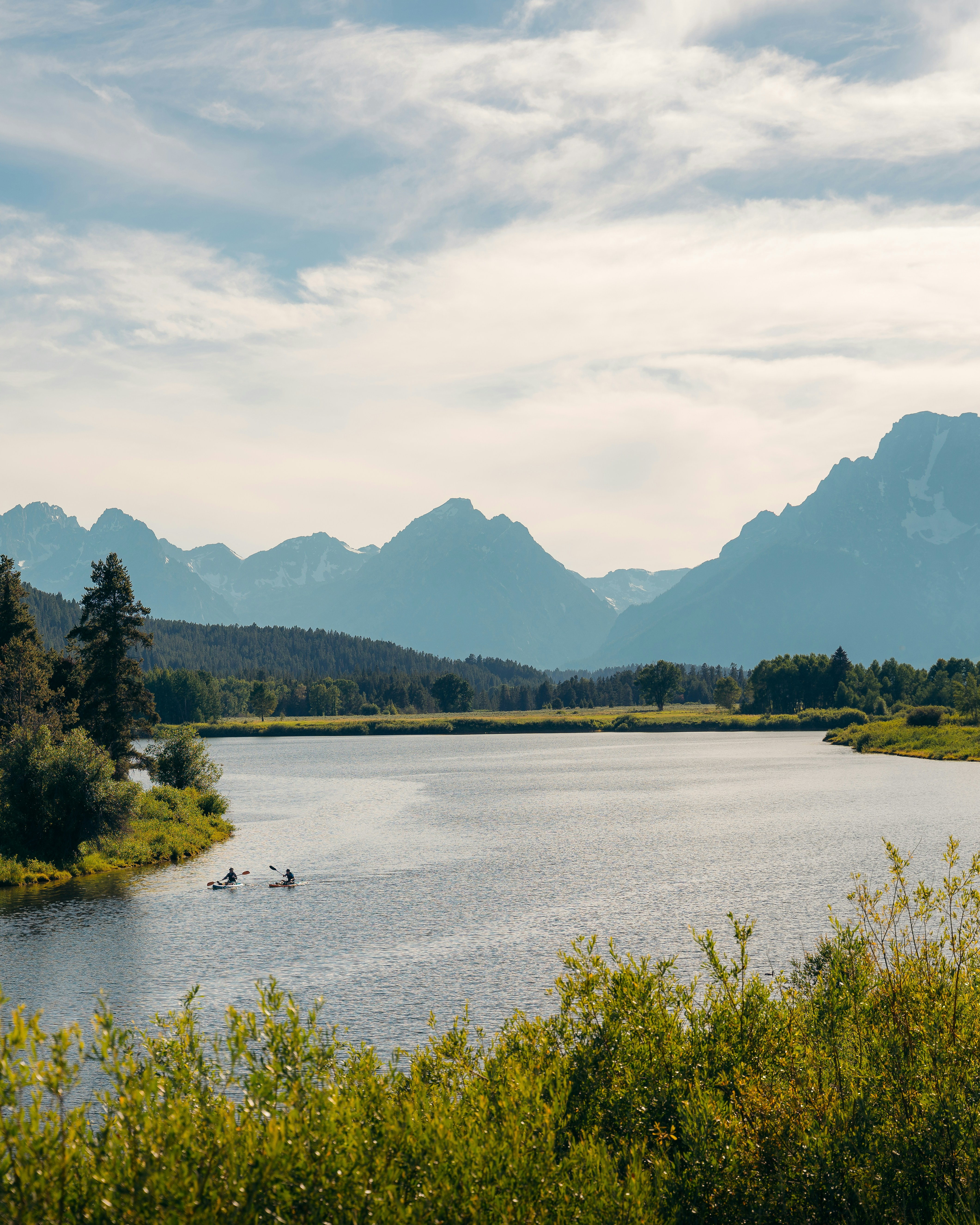 Serene river bend beneath jagged alpine peaks