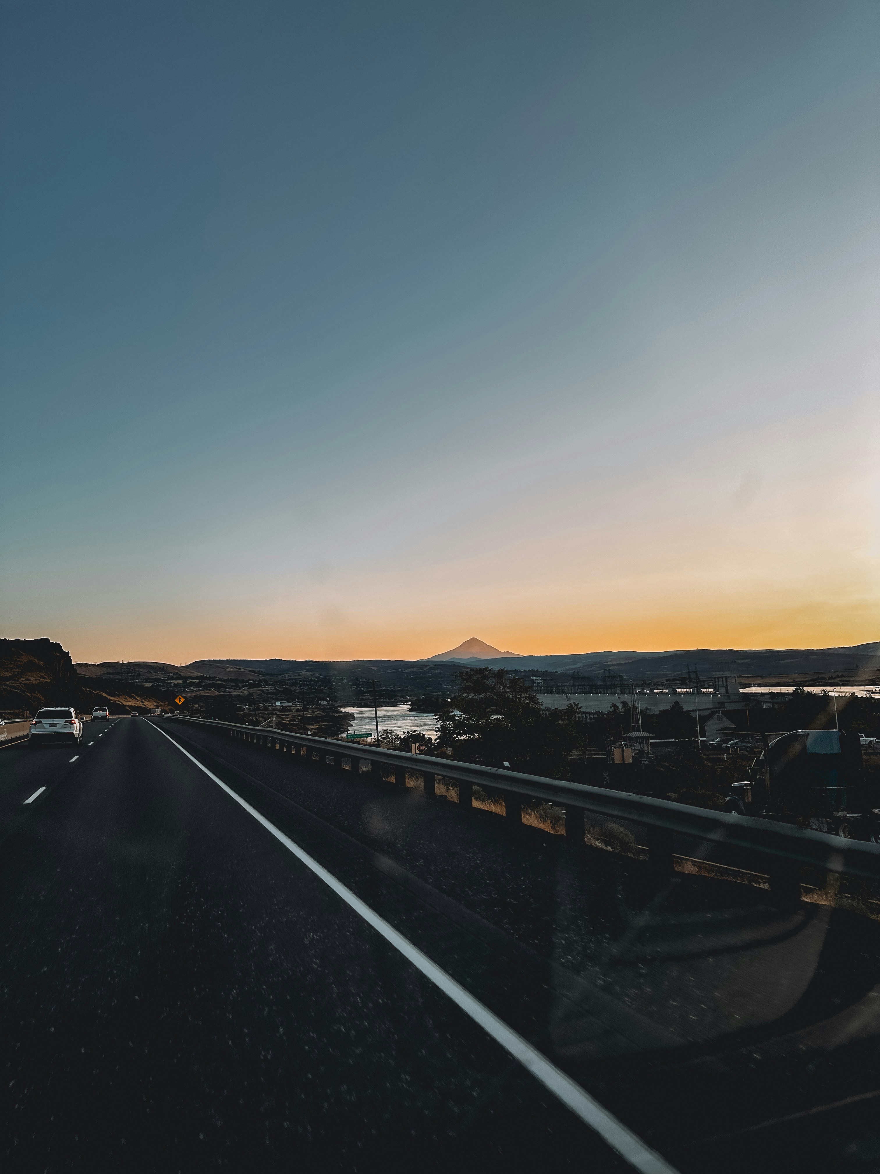 Dusk Highway: Conical Peak on the Quiet Waterfront Horizon