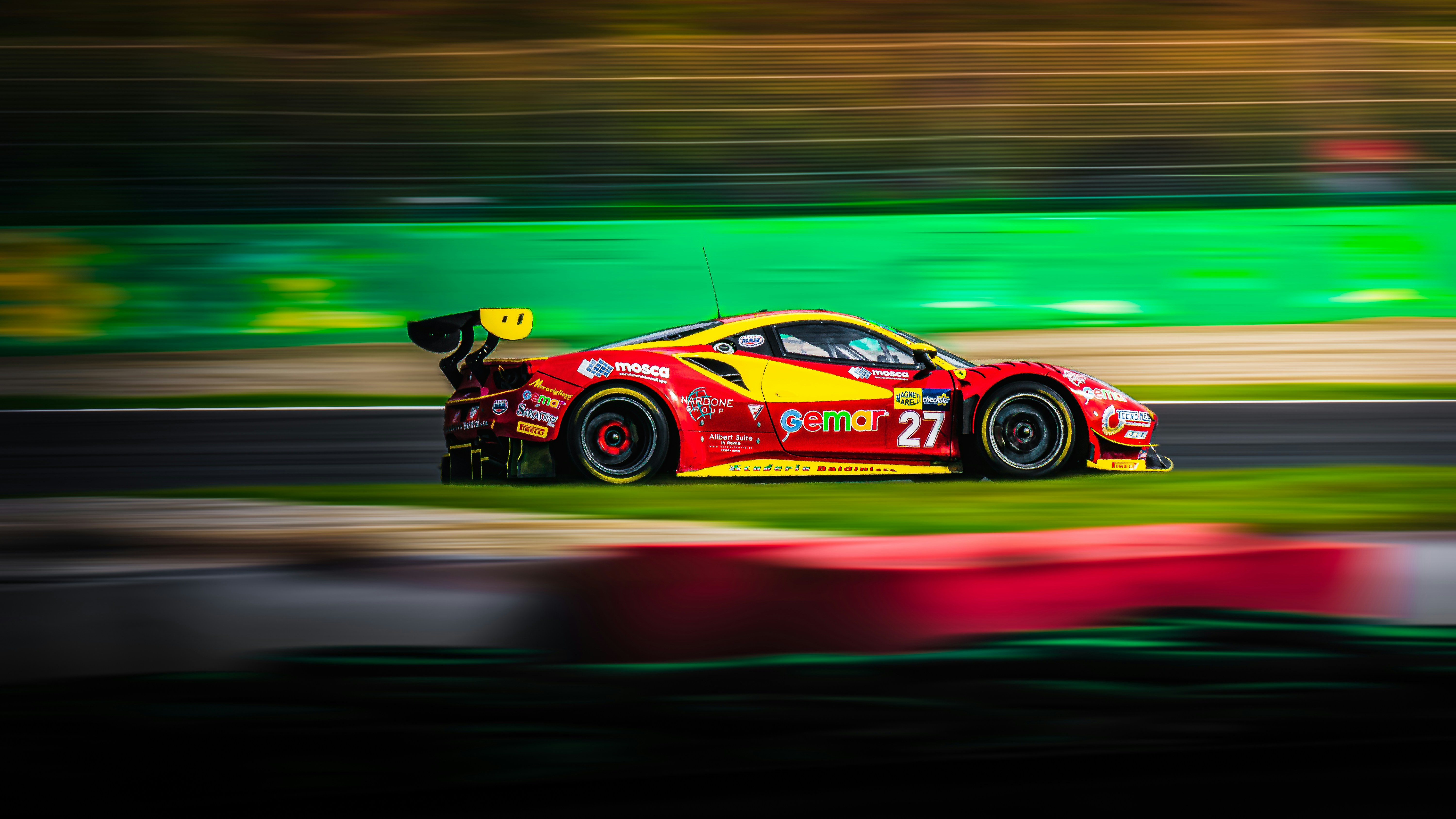 A red and yellow race car driving on a track photo – Free Italy Image ...