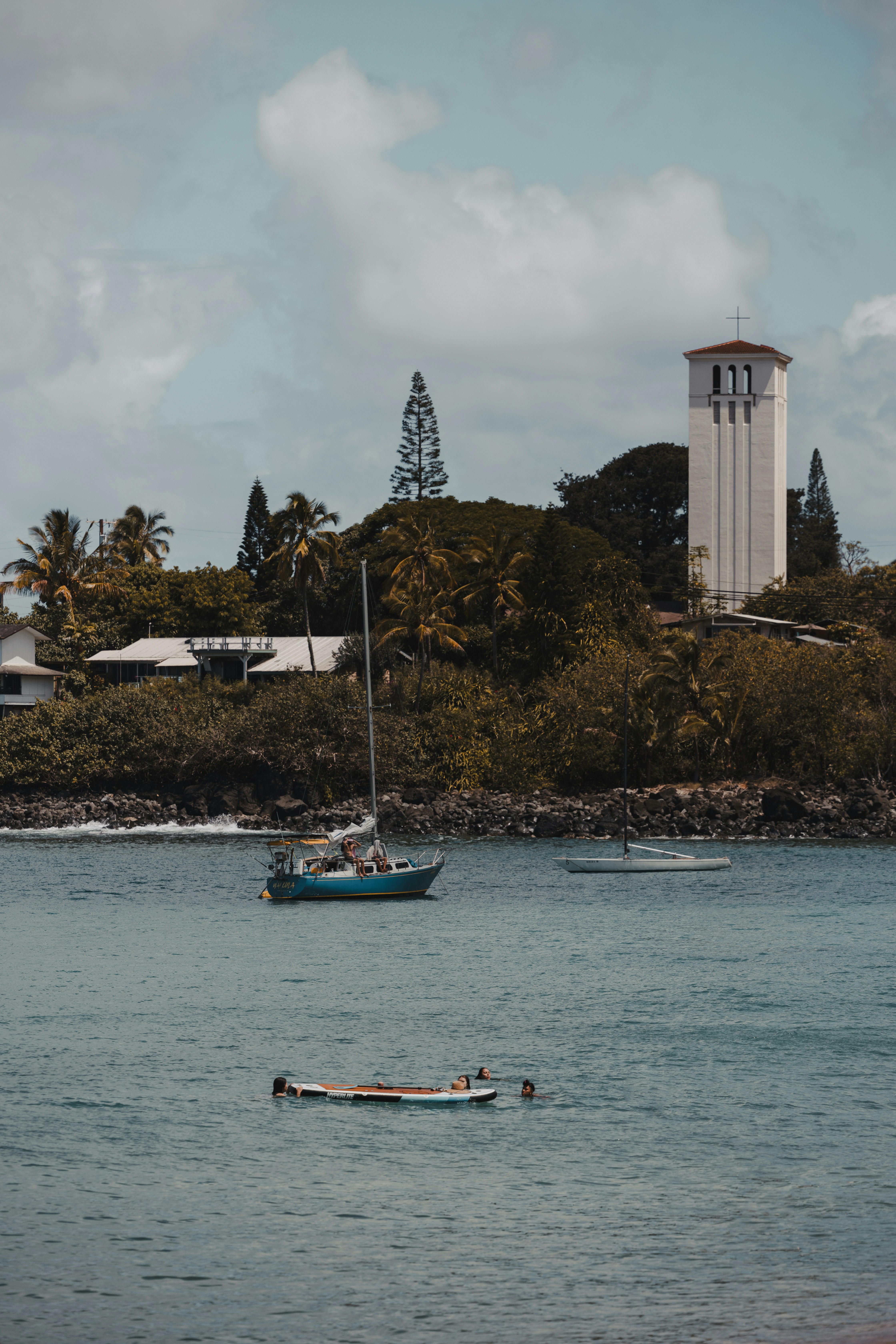 Harbor Beacon: A White Tower Over a Palm-Lined Shore