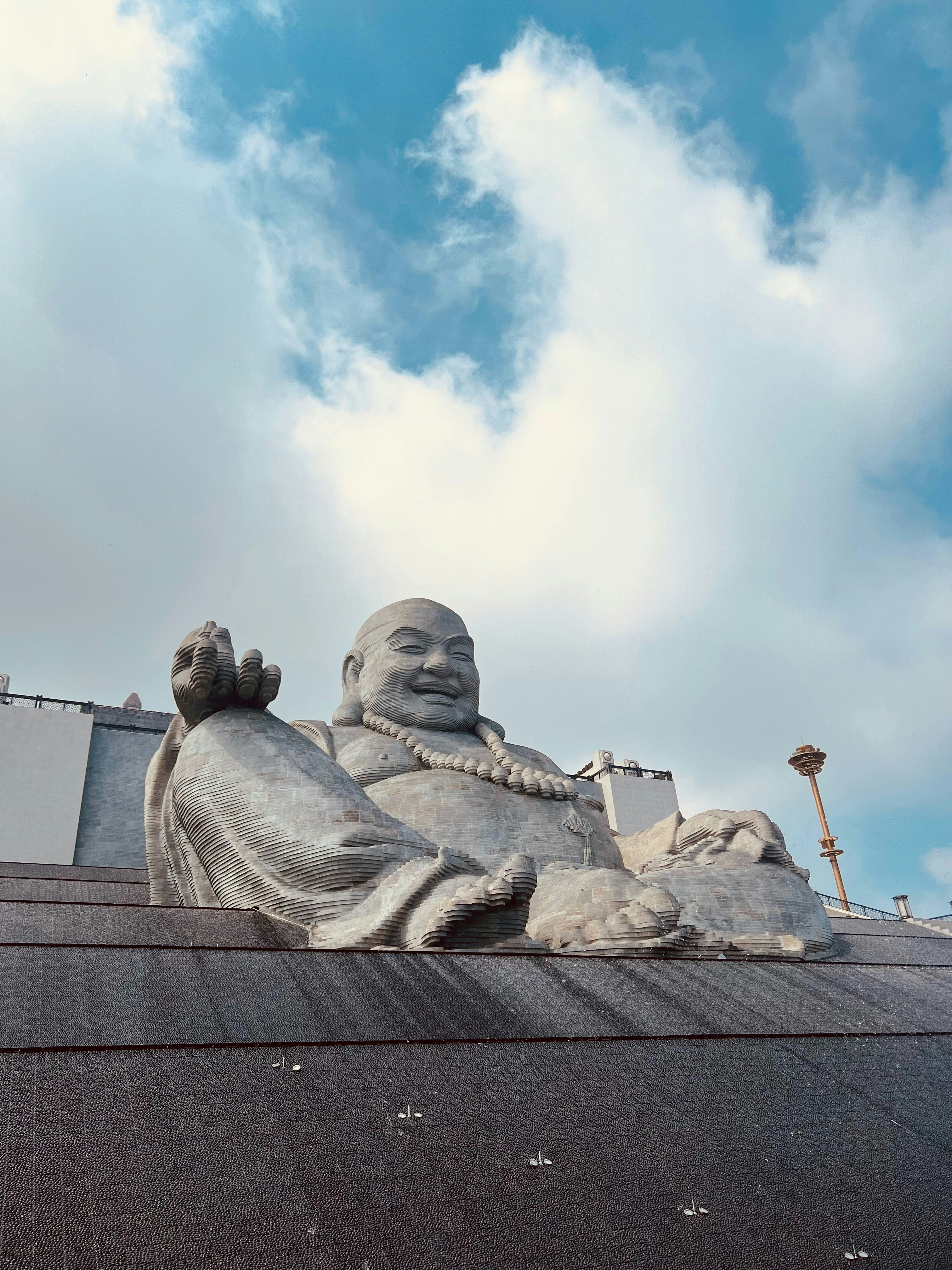 Laughing Buddha on the Rooftop: Granite Calm Under an Open Sky