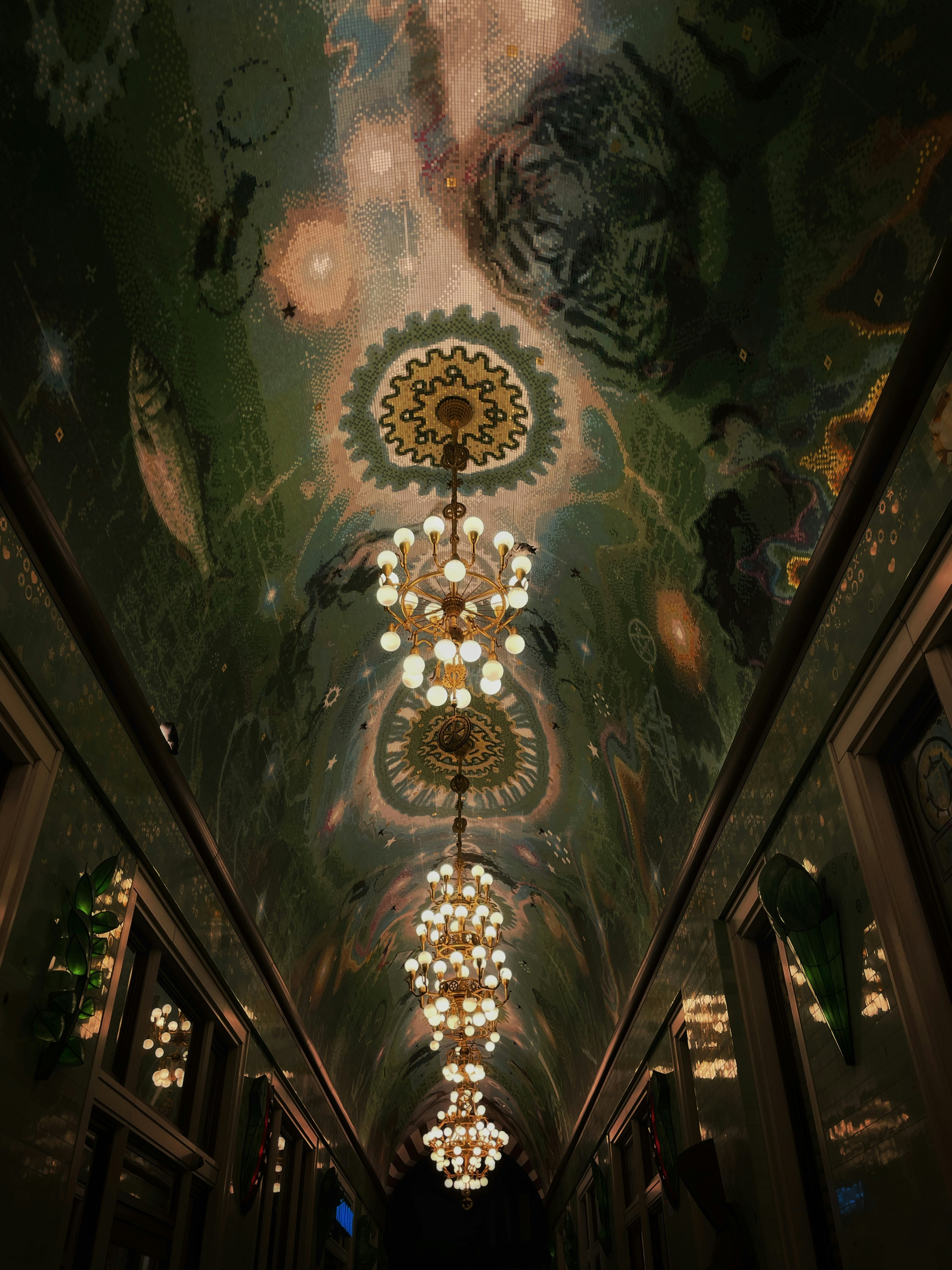 Emerald Vault: Chandeliers Leading Through a Verdant Corridor