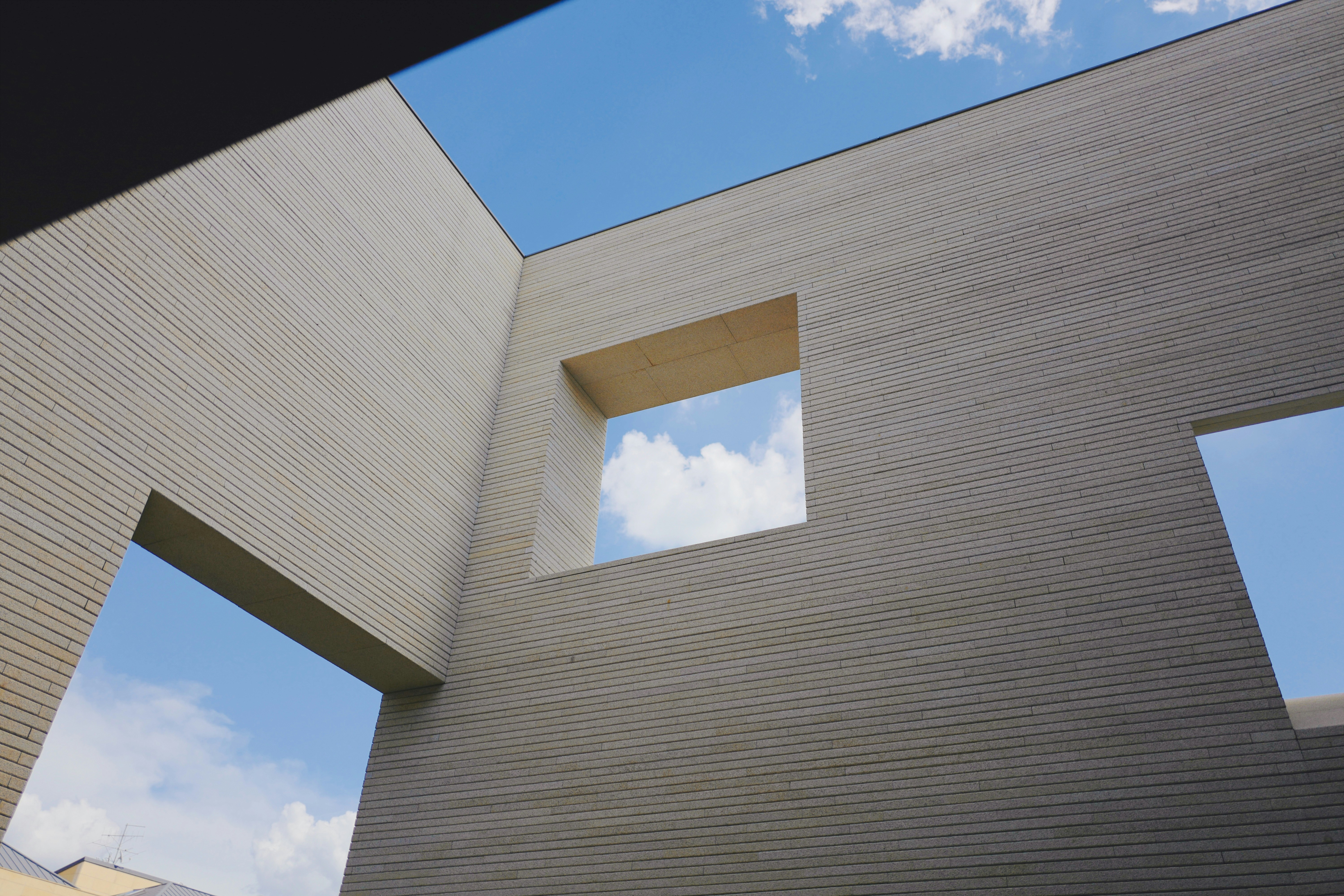 A view of the sky through a window in a building photo – Free Building ...