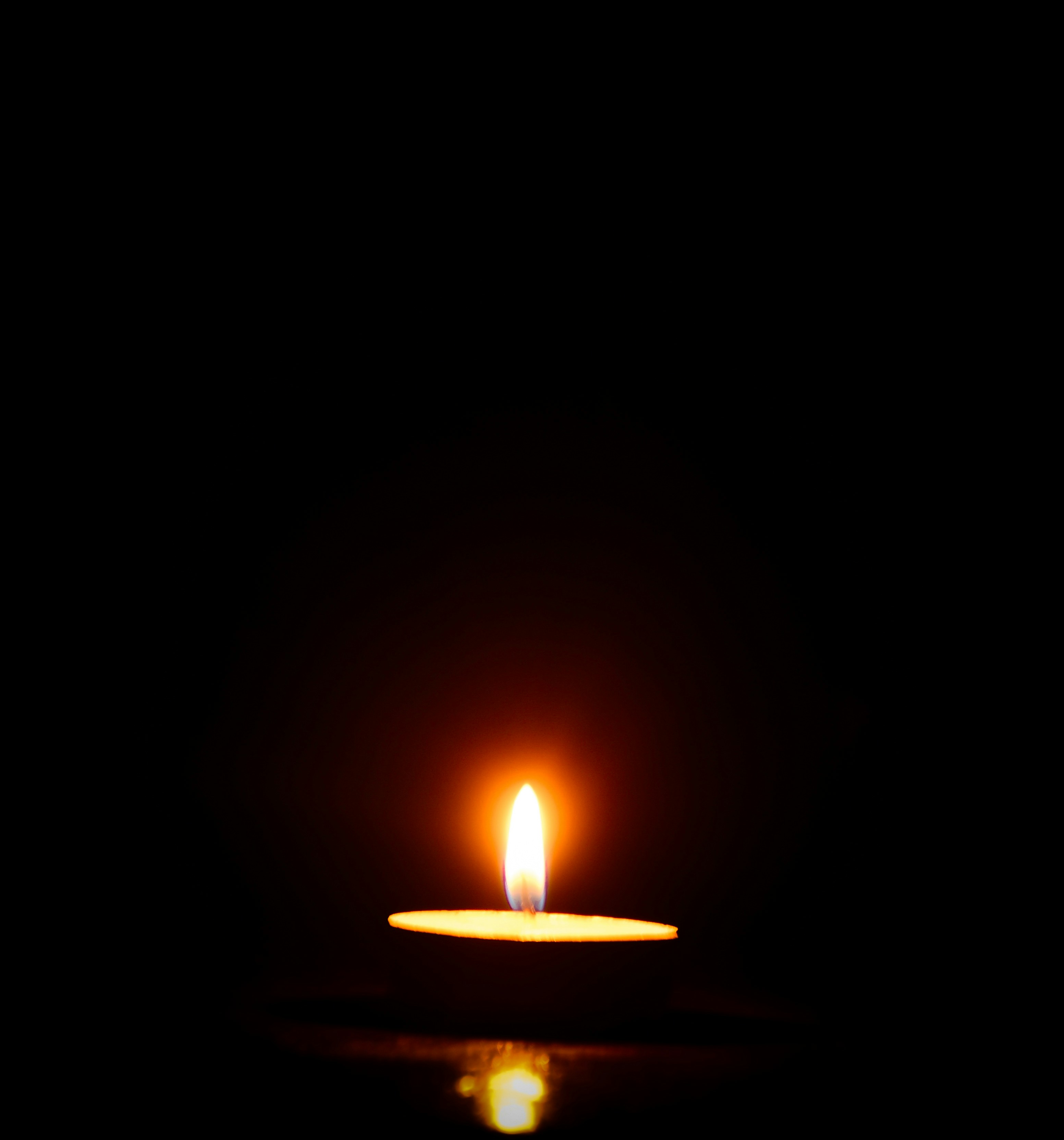 Solitary Candlelight: Warmth Emerges from Velvet Darkness