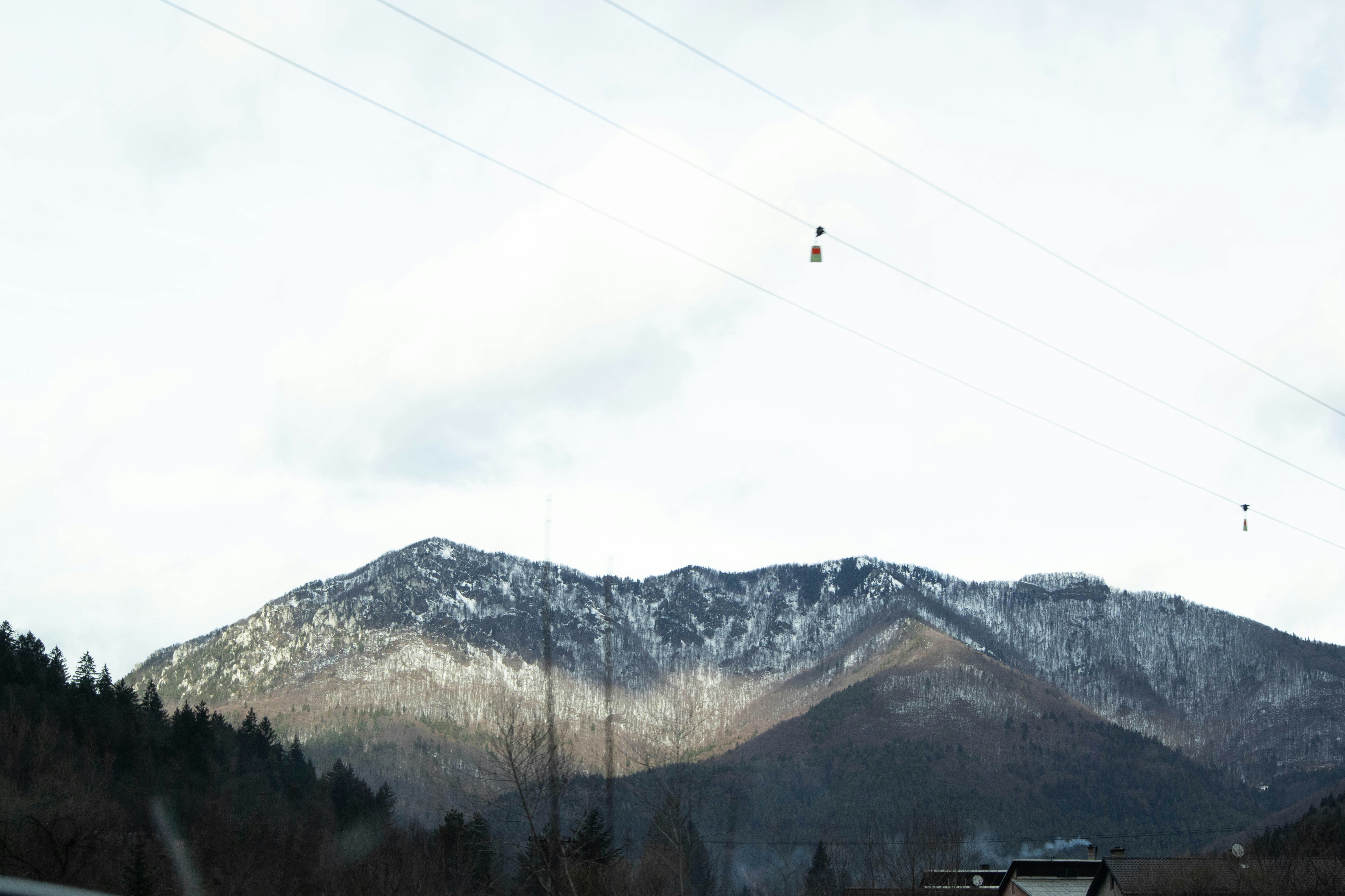 Snow-Kissed Ridge Under Cable Car Gulls
