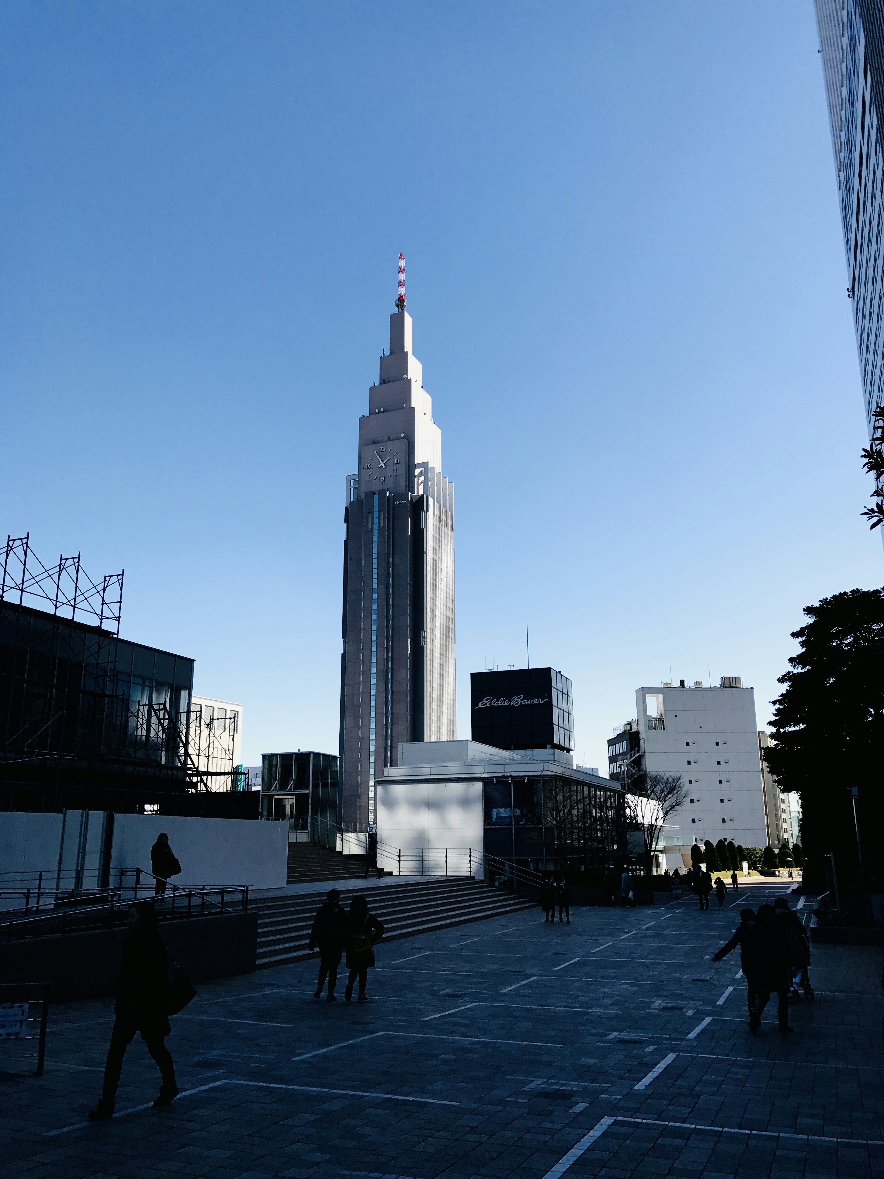 Staircase Spire Rising Over a Modern Plaza Under a Clear Blue Sky