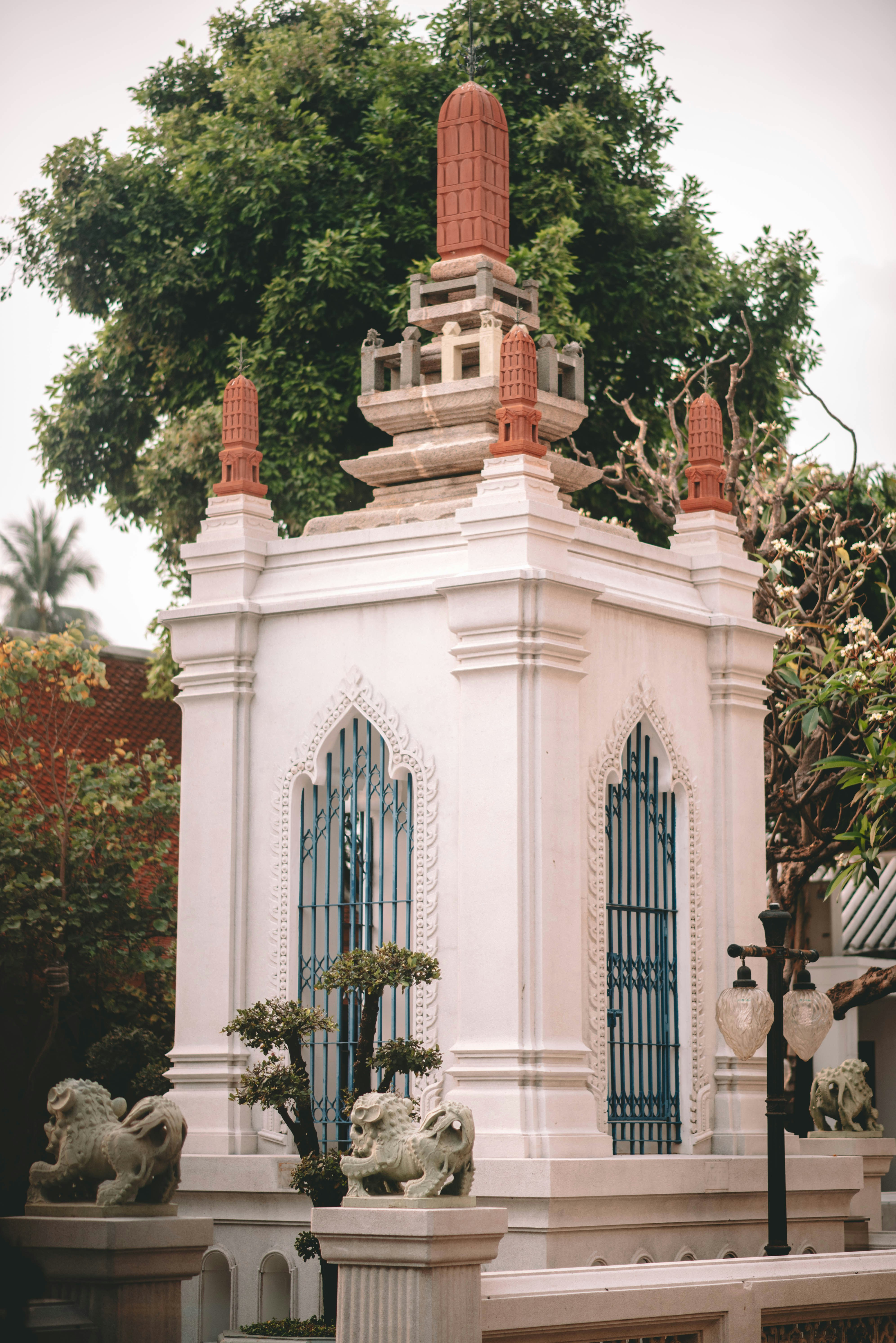 Red-Capped Towers Guard a White Temple in a Quiet Garden