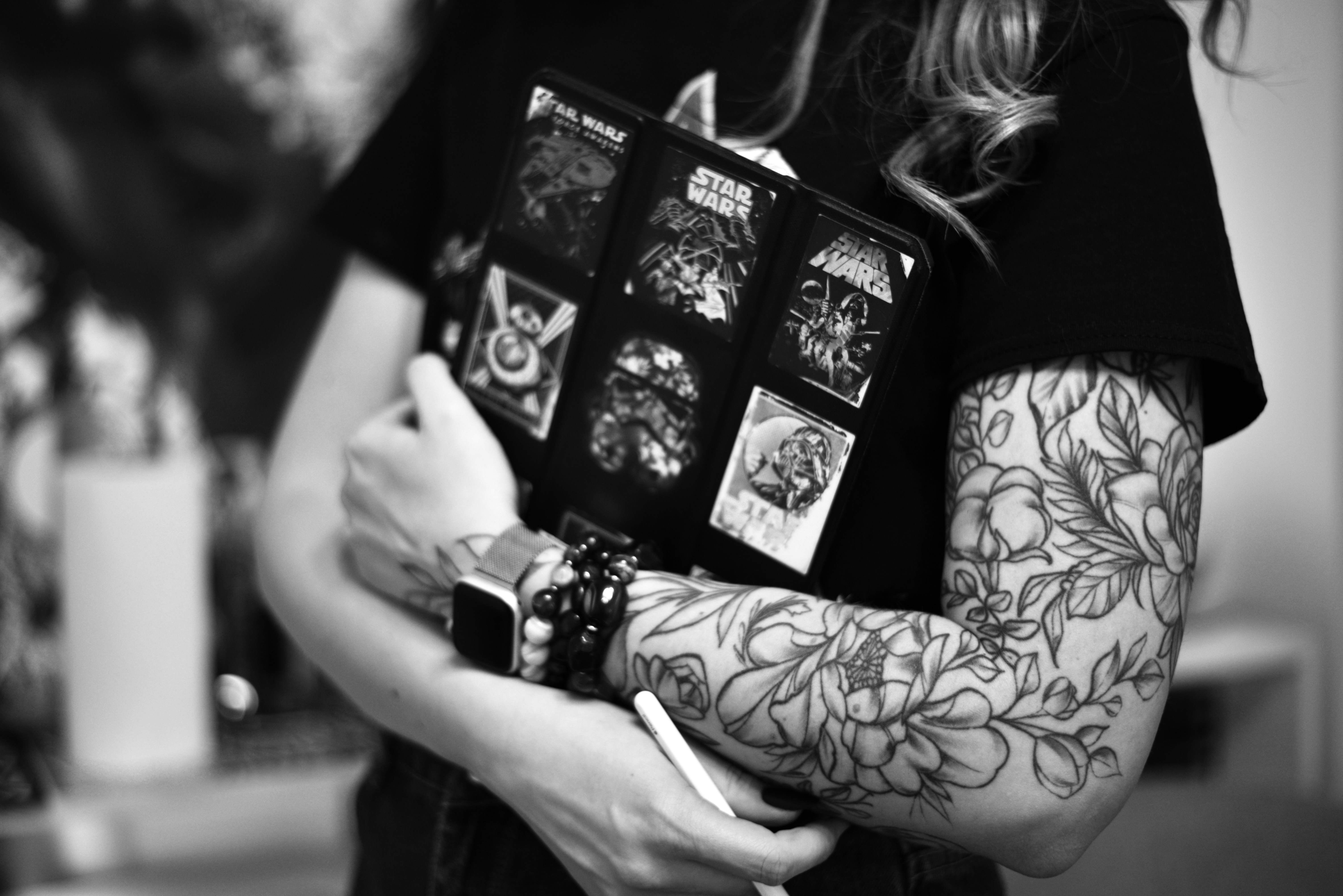 Ink and Orbit: A Tattooed Arm Cradling a Star Wars Card Deck