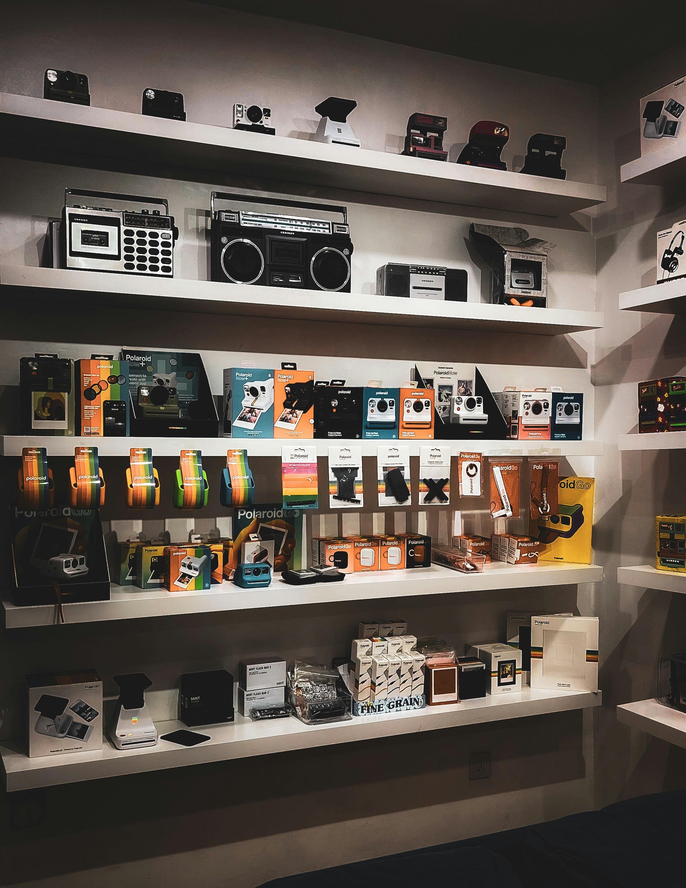 Retro Echo: A Wall of Vintage Tech on White Shelves