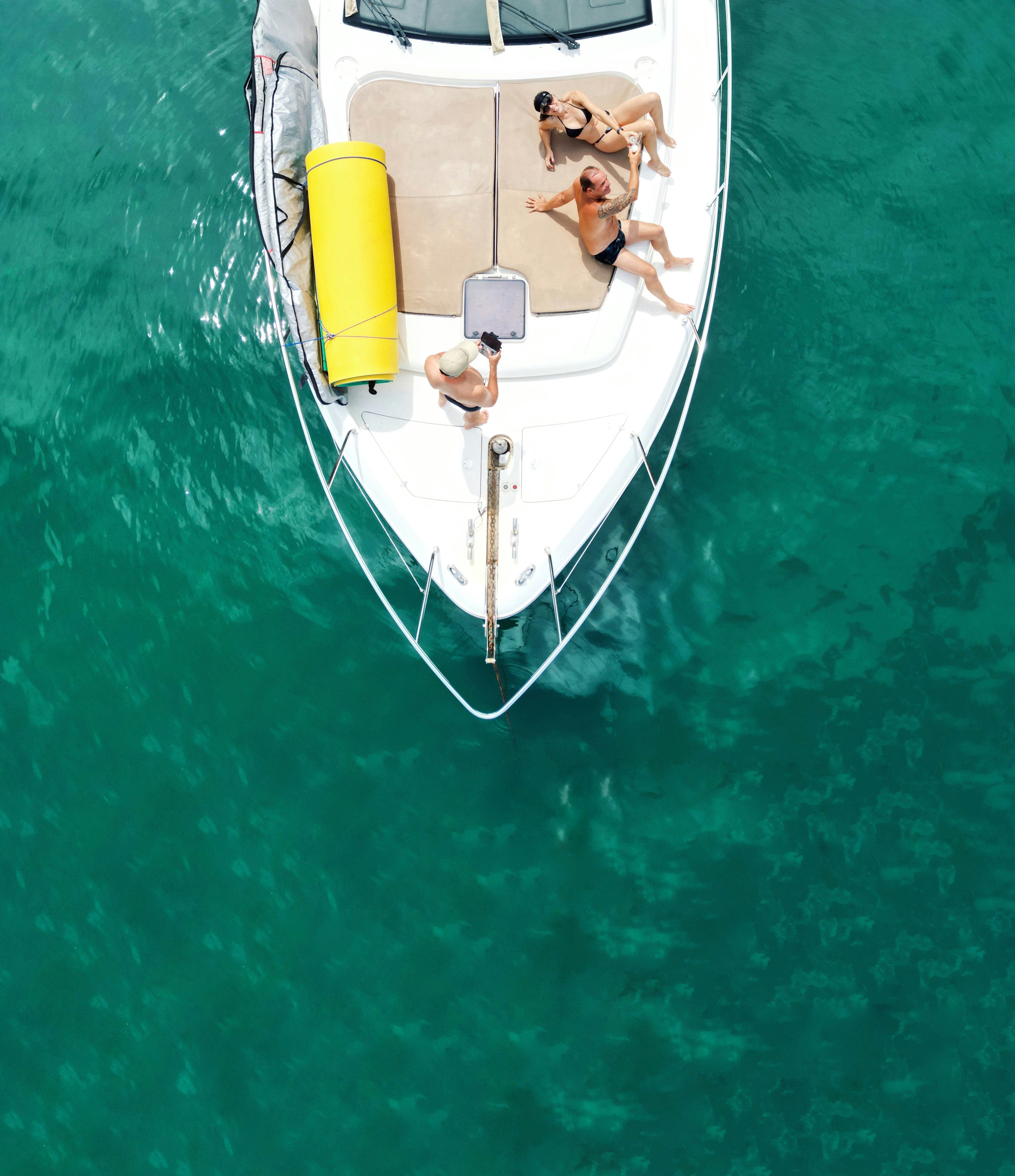 Emerald Wake: Aerial Portrait of a Sunlit Boat Party