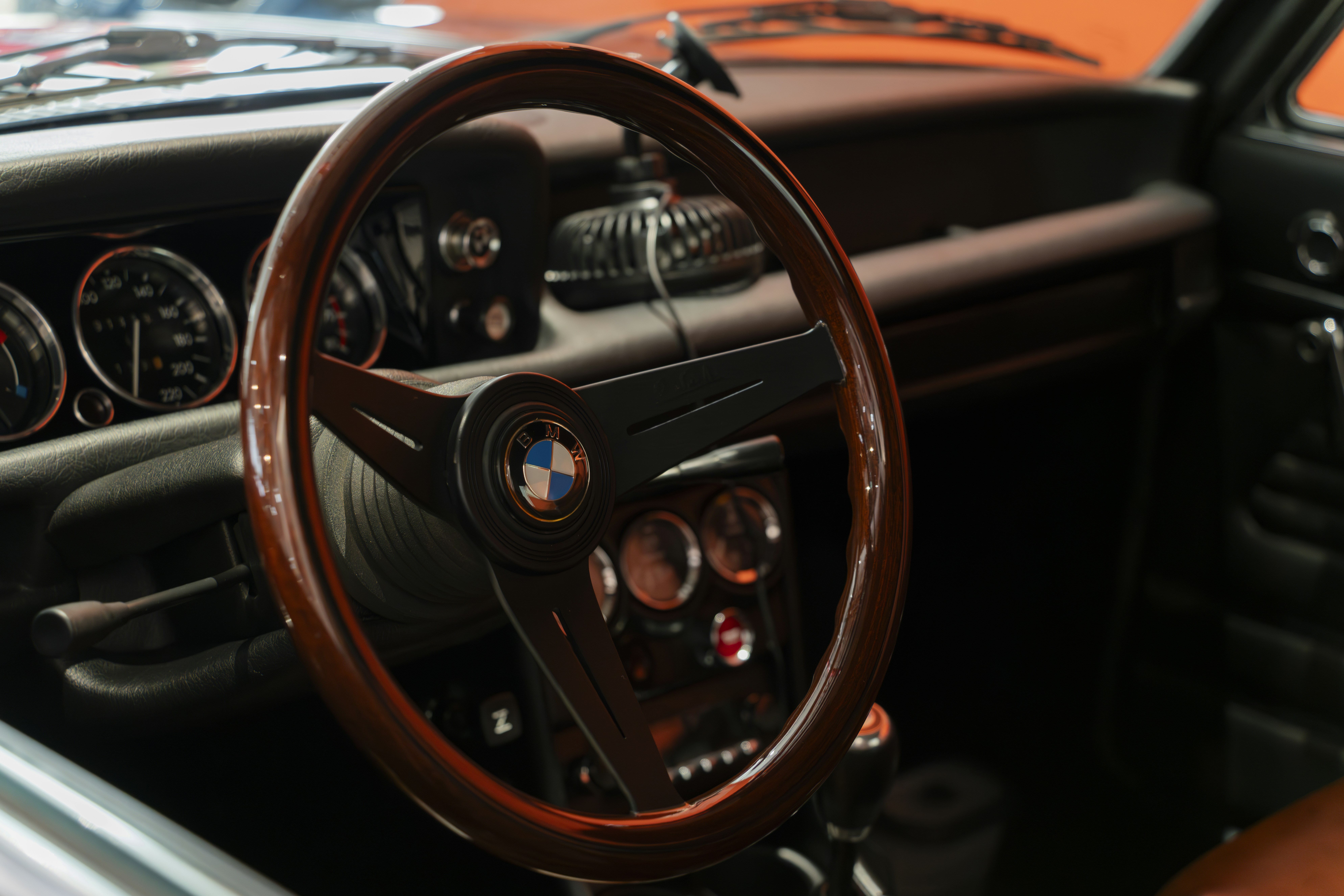 Steering the Classic: A Glimpse of Vintage BMW Craft through a Rich Brown Steering Wheel