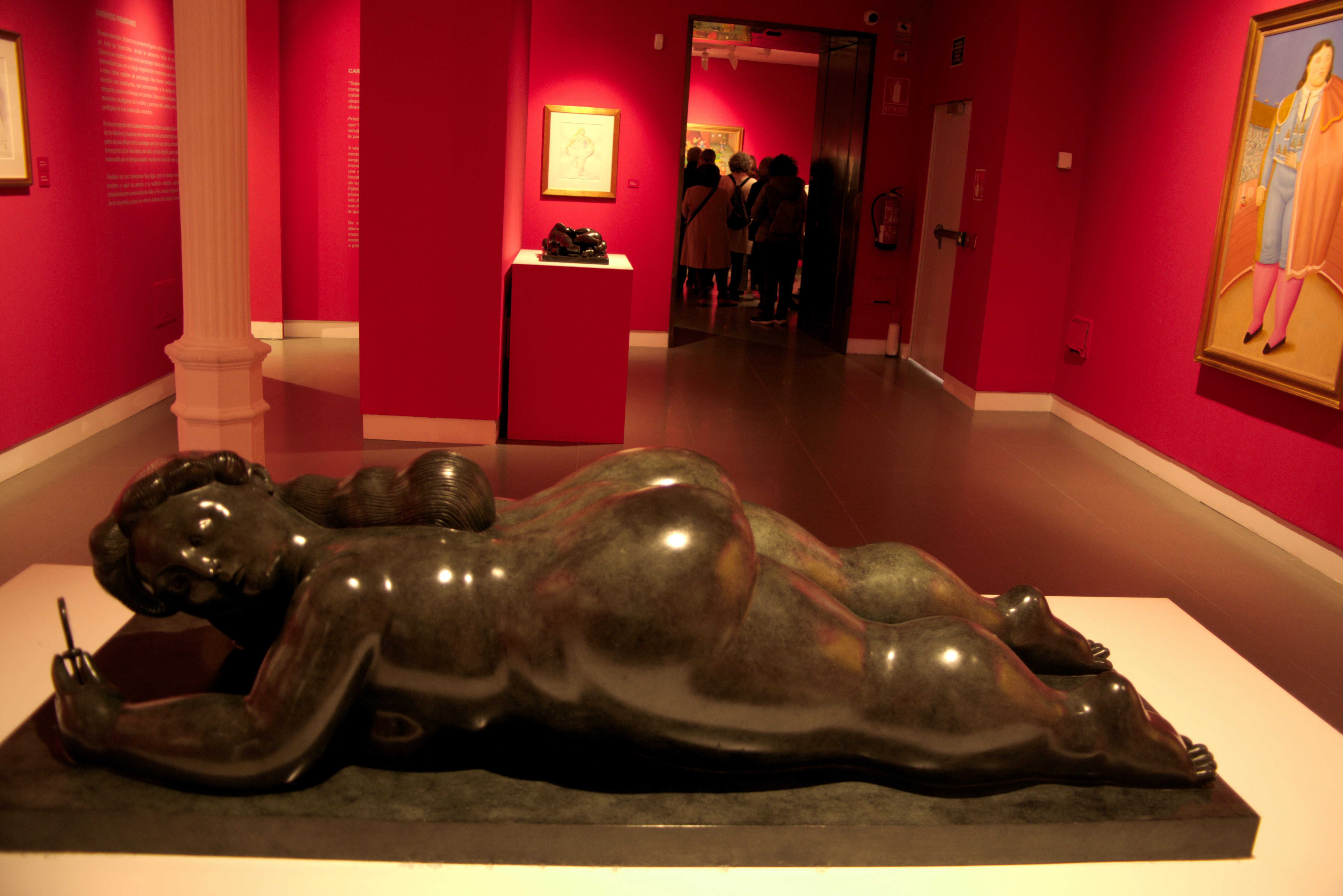 Reclining Bronze Form in a Crimson Gallery