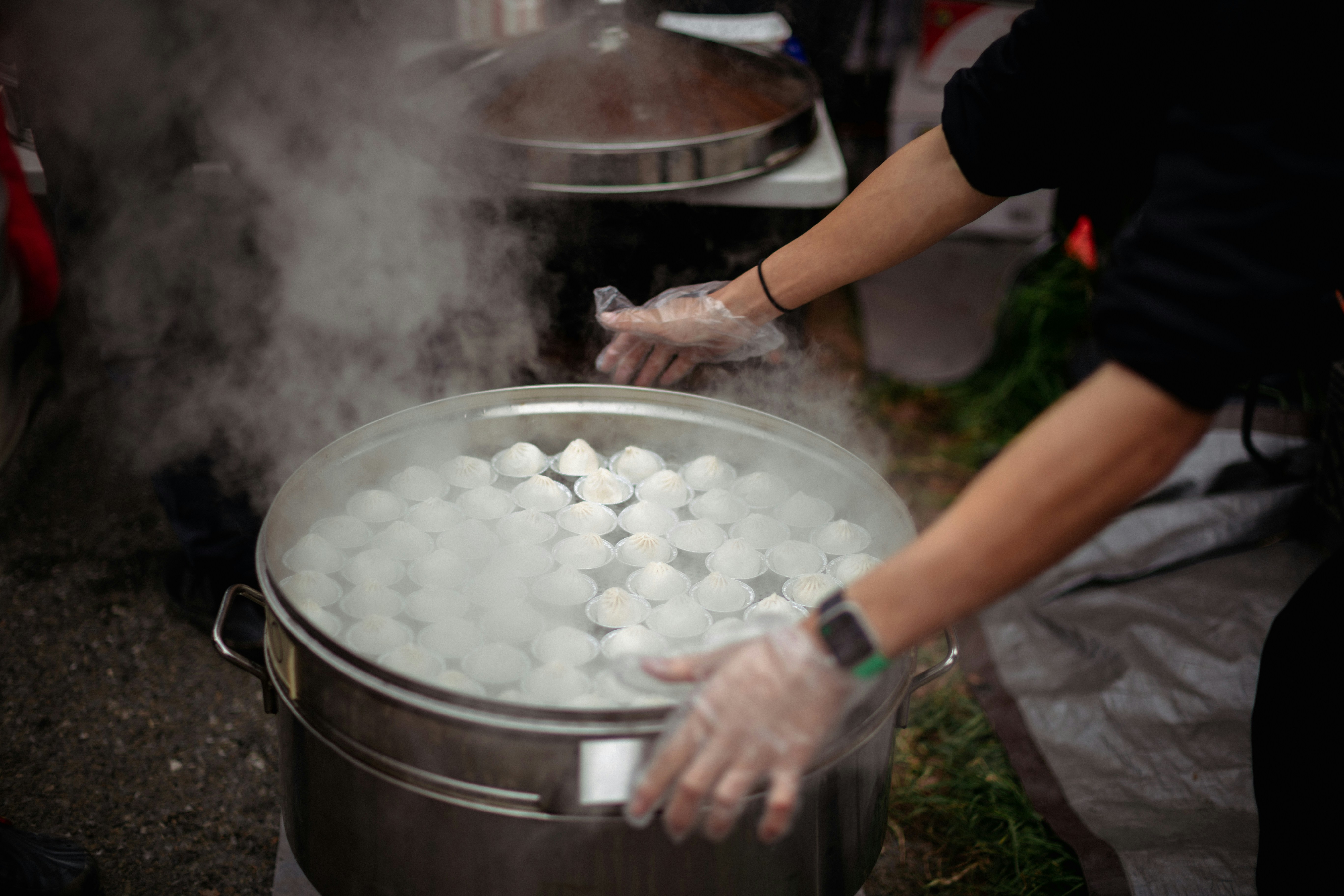Steaming Dumplings in a Copper Pot: Steam Rising Over a Busy Outdoor Kitchen