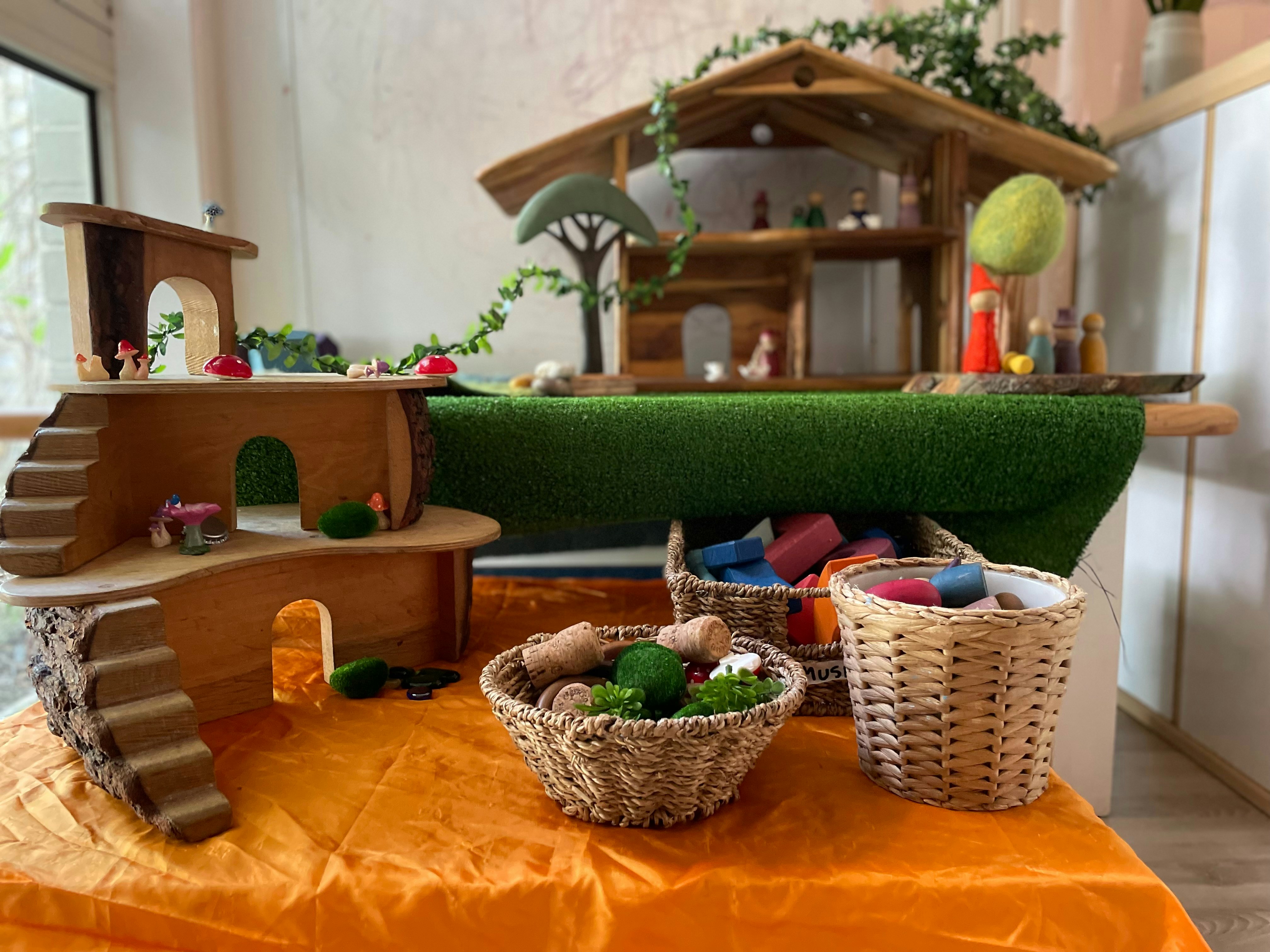 Tiny Village on Orange Cloth: Mossy Baskets, Wooden Terraces, and a Miniature Landscape