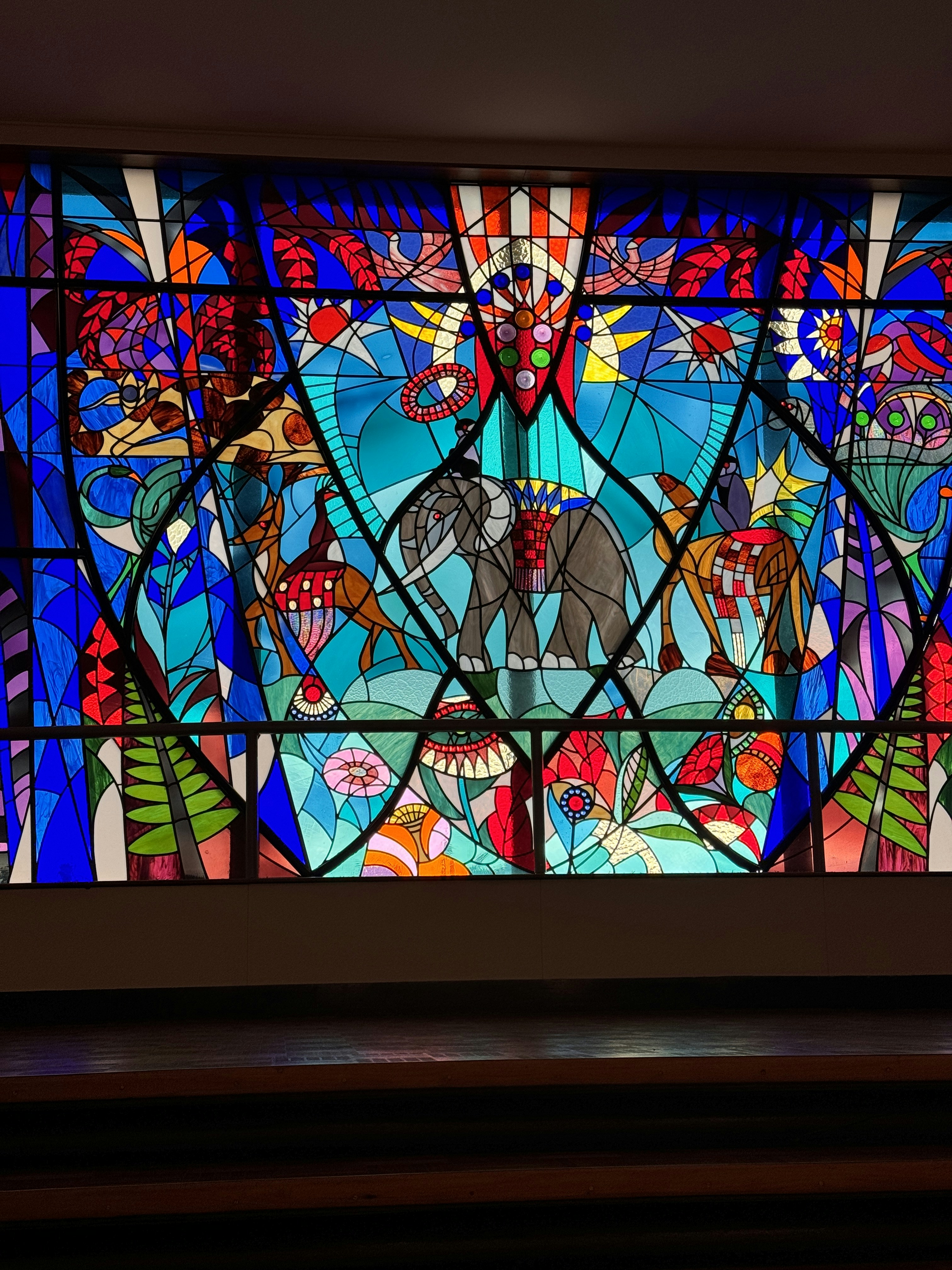 Central Elephant in a Prismed Mosaic: A Kaleidoscopic Stained-Glass Scene