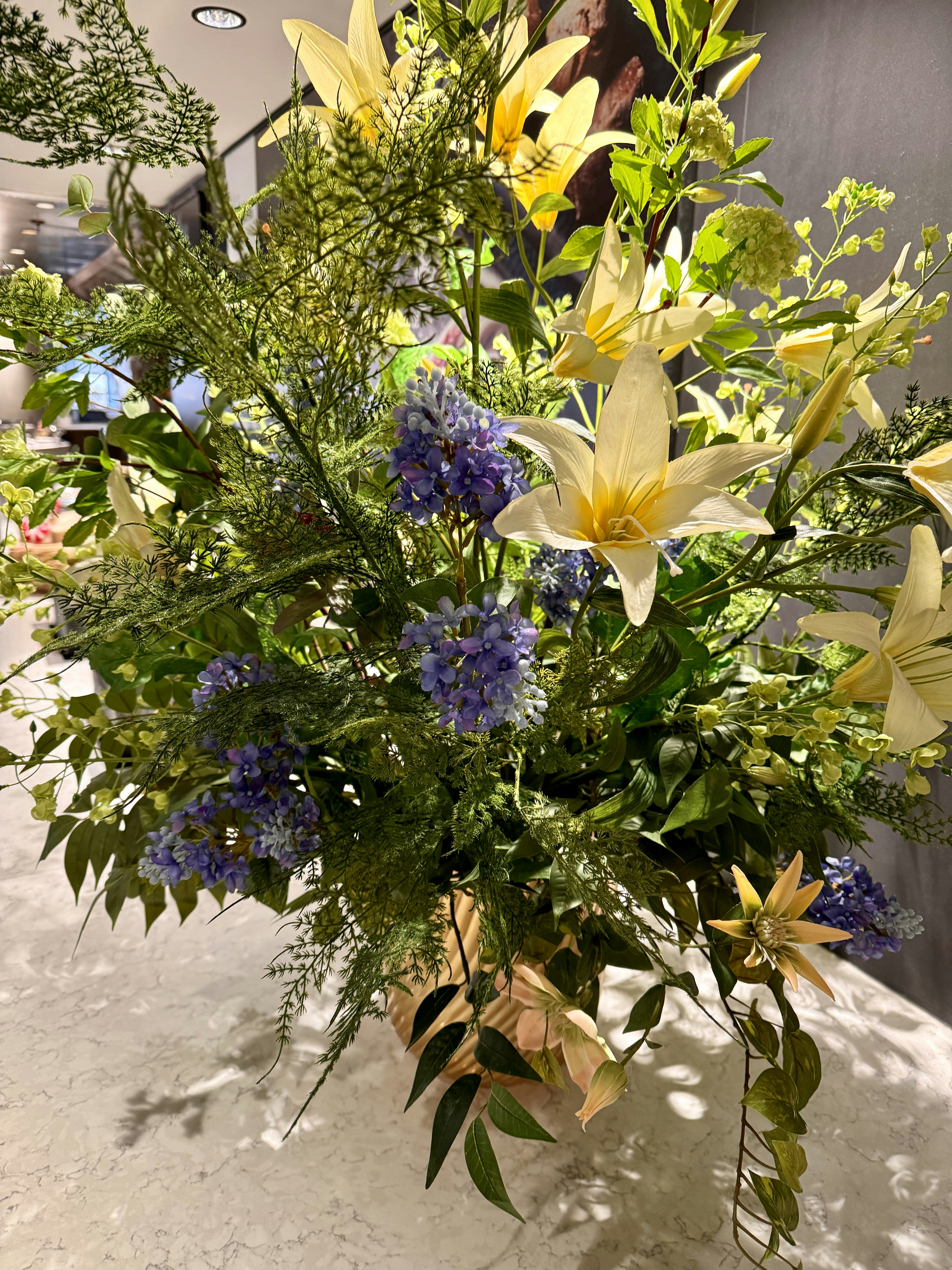 Sunlit Lilies Meet Indigo Blooms: A Floral Centerpiece