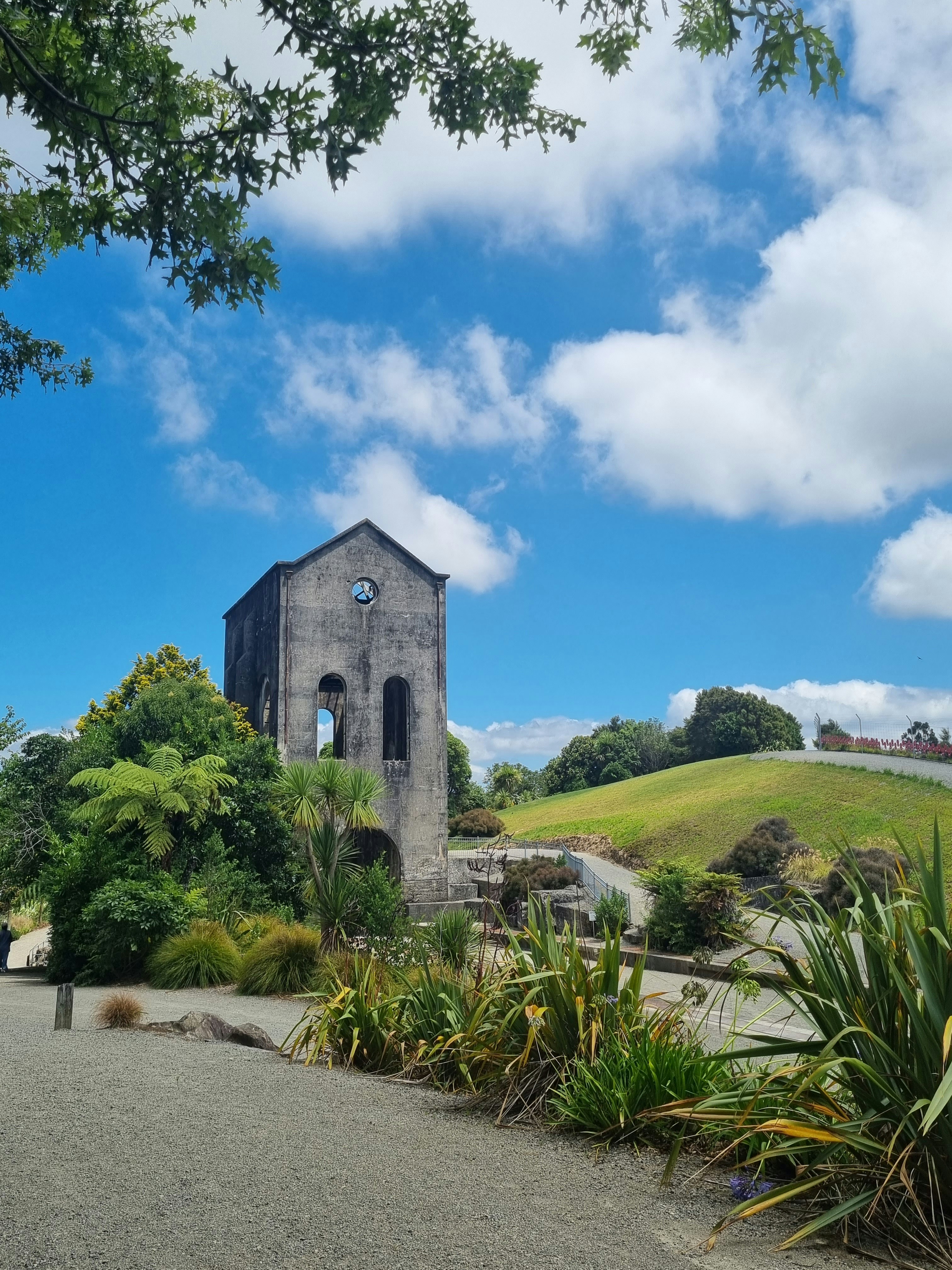 Stone Bell Tower Rising from a Lush Terrace