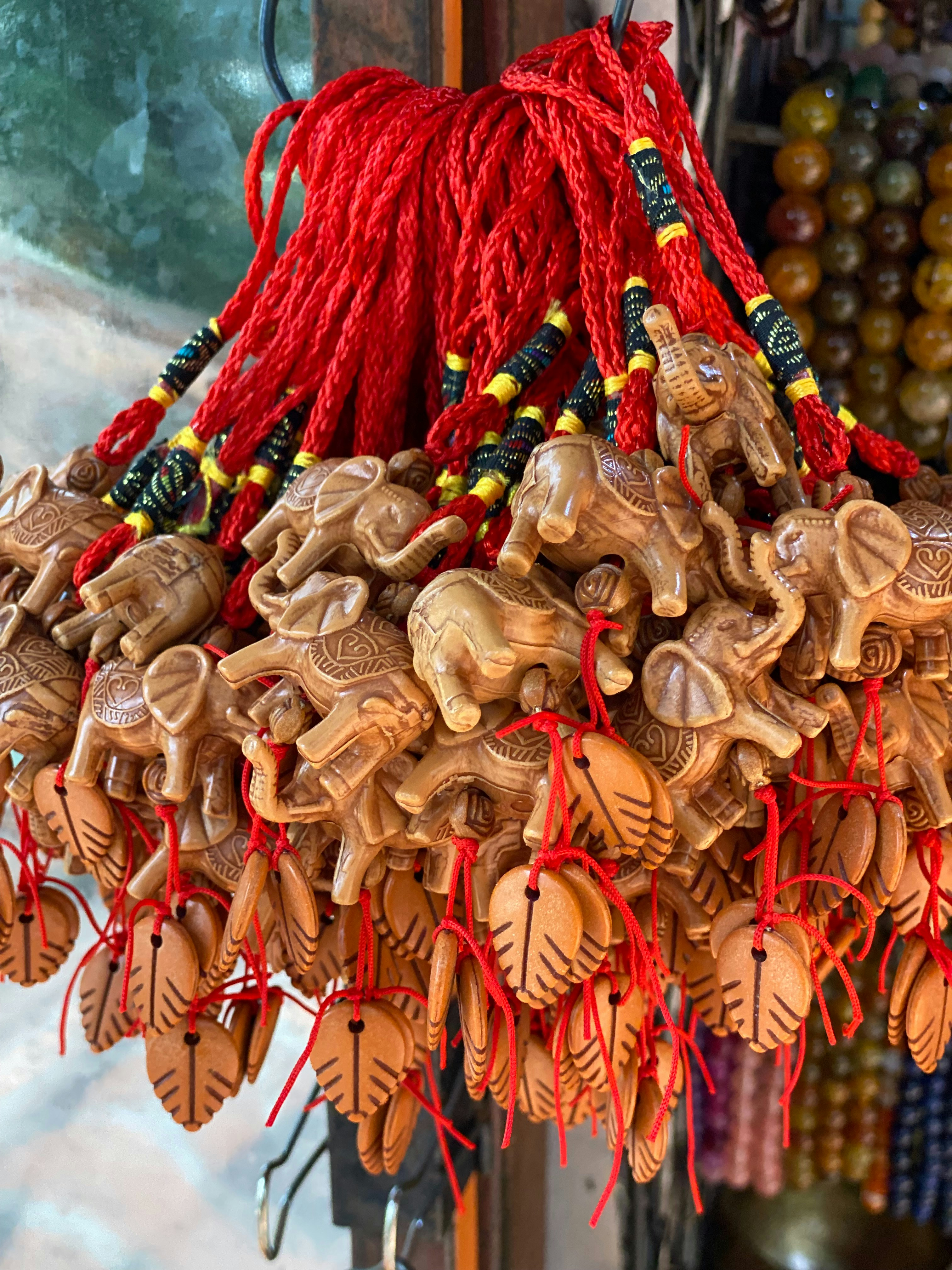 A bunch of wooden ornaments hanging from a ceiling photo – Free Woman ...